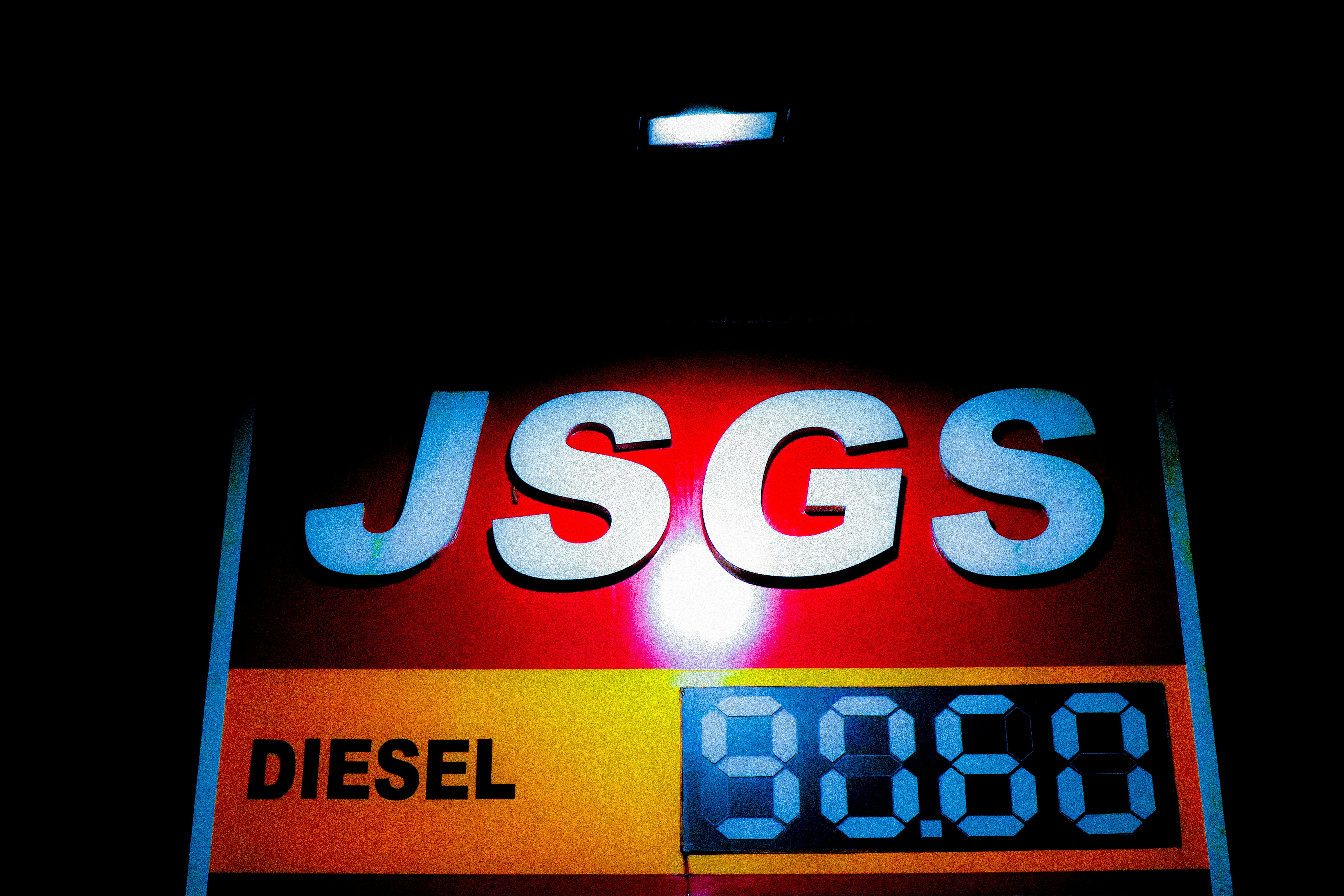 Diesel Price Glow: Neon Blue Digits Against a Dark Fuel Station