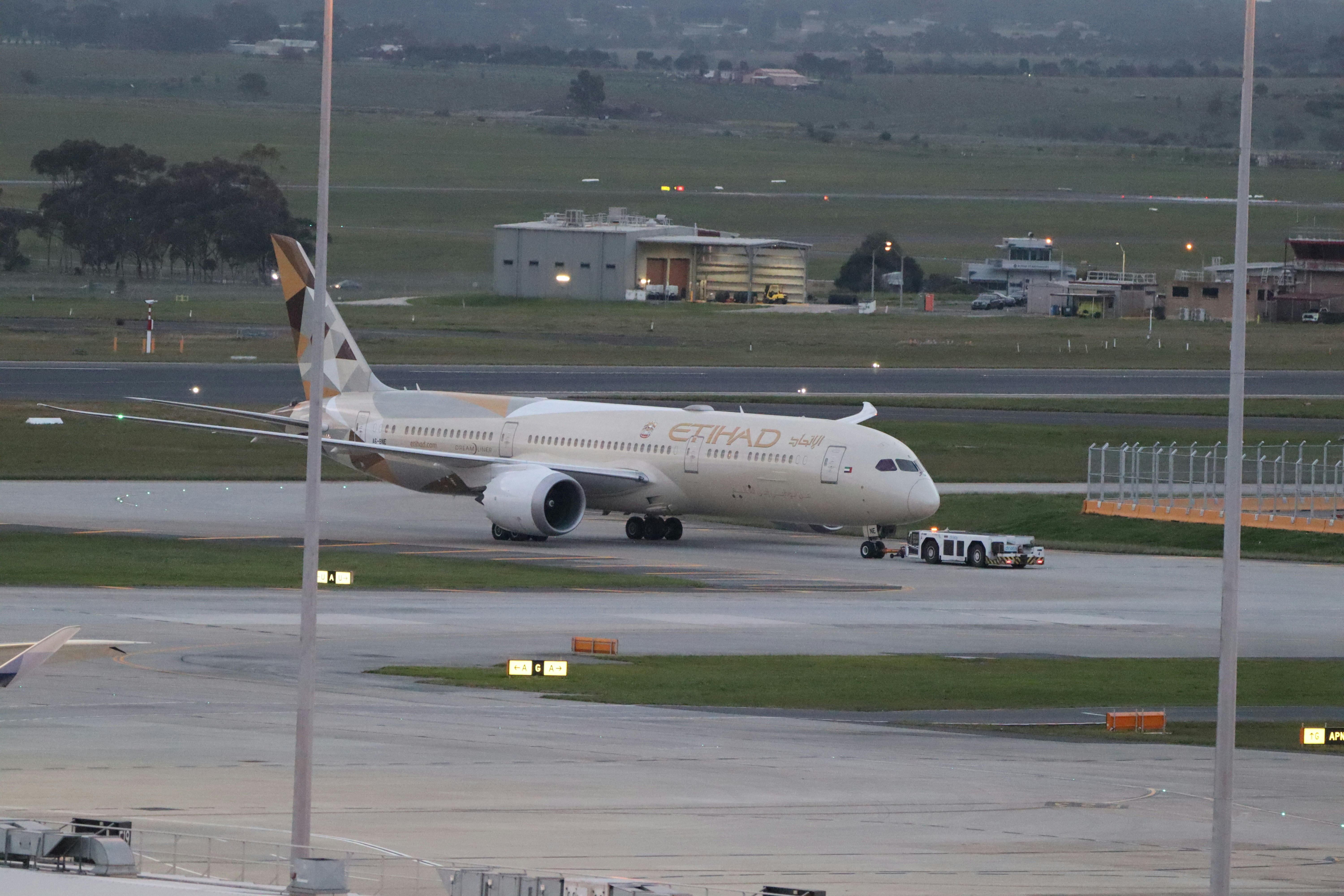 Etihad A350 on the taxiway bathed in early-evening light