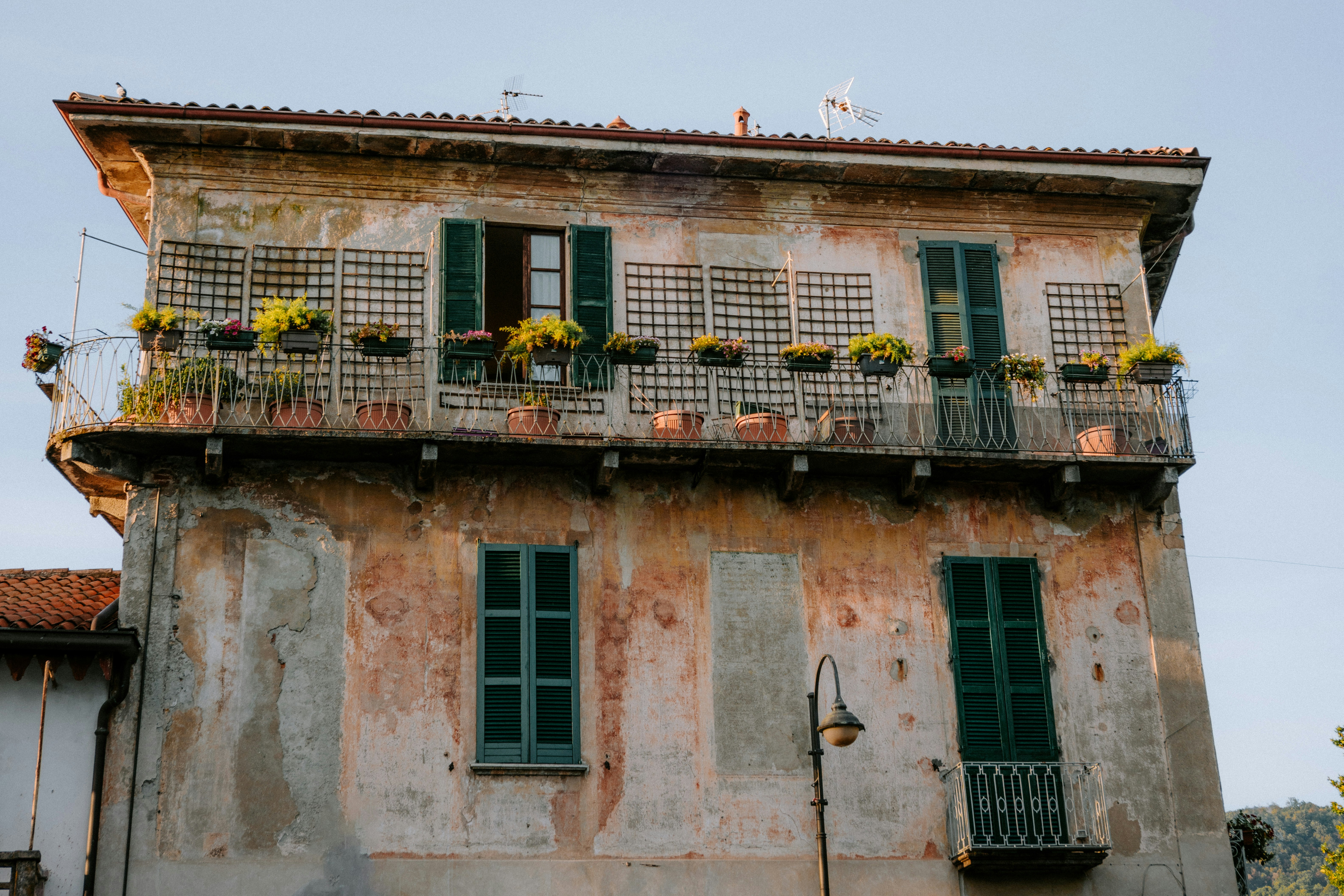 Balcony of Sunlit Pots: A Weathered Italian Villa