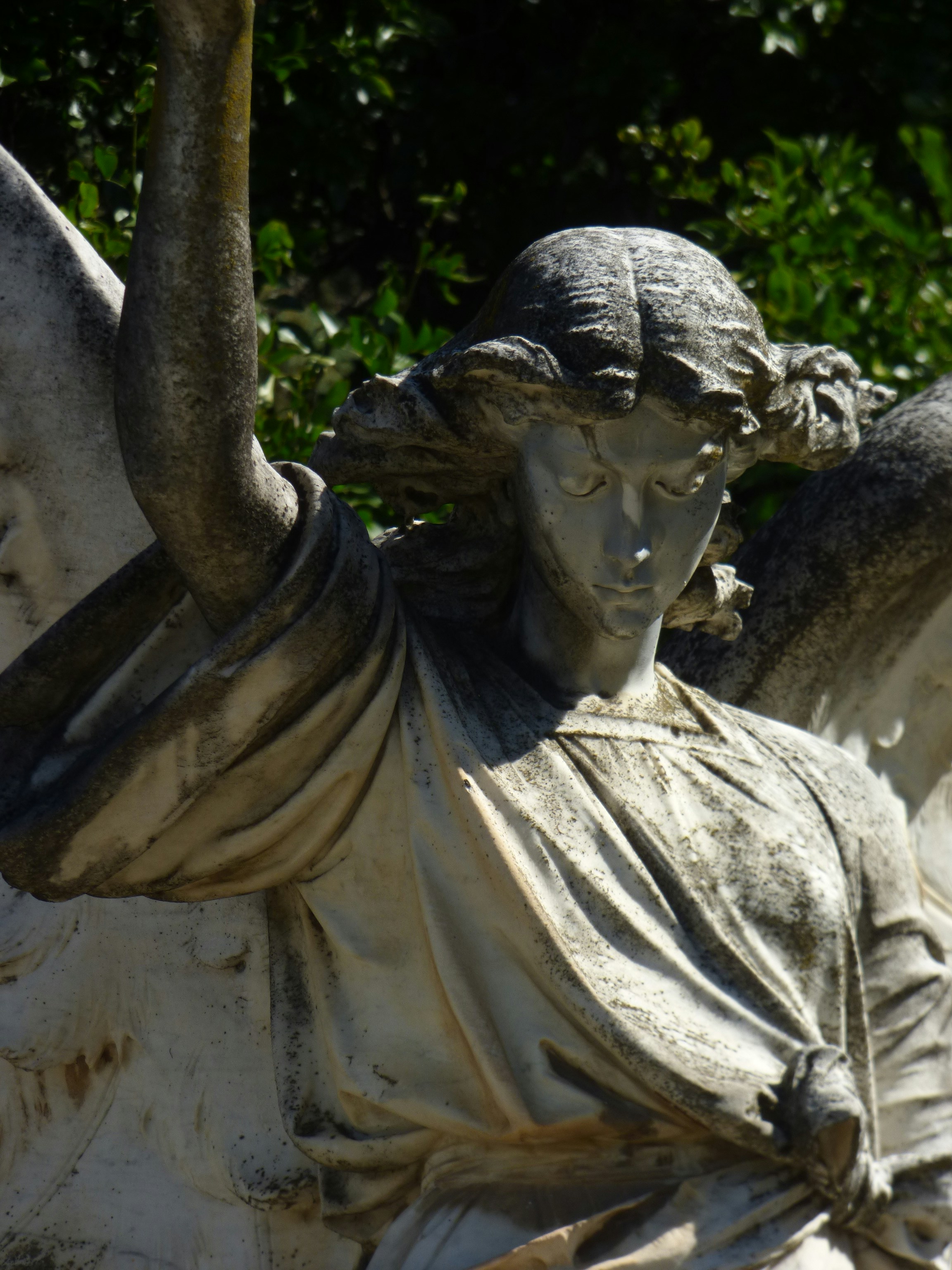 Winged Sentinel: A Weathered Angel in Soft Sunlight