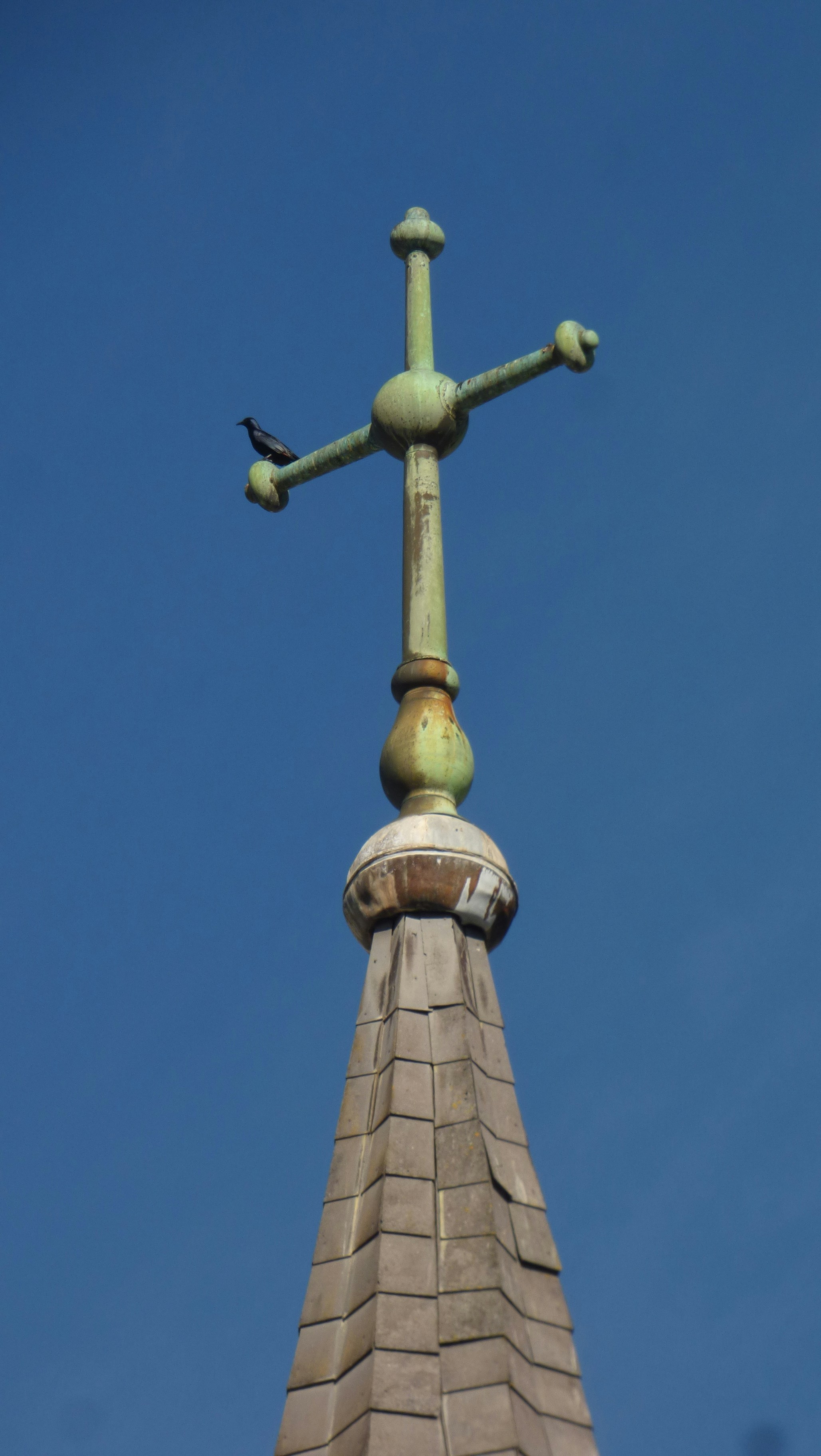 Copper Cross Soaring Against a Clear Blue Sky