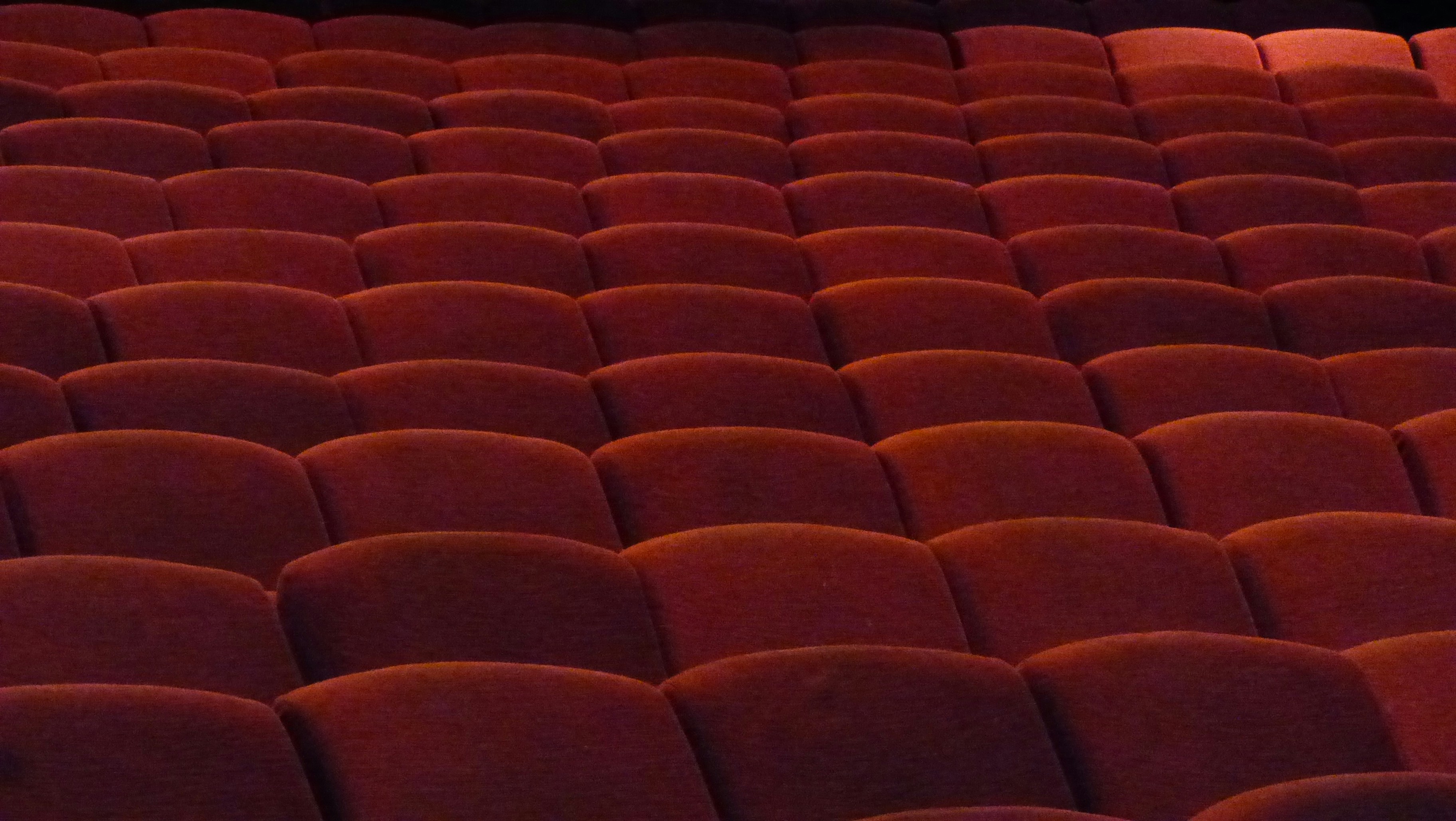 Red Velvet Rows: An Empty Theater’s Tactile Echo