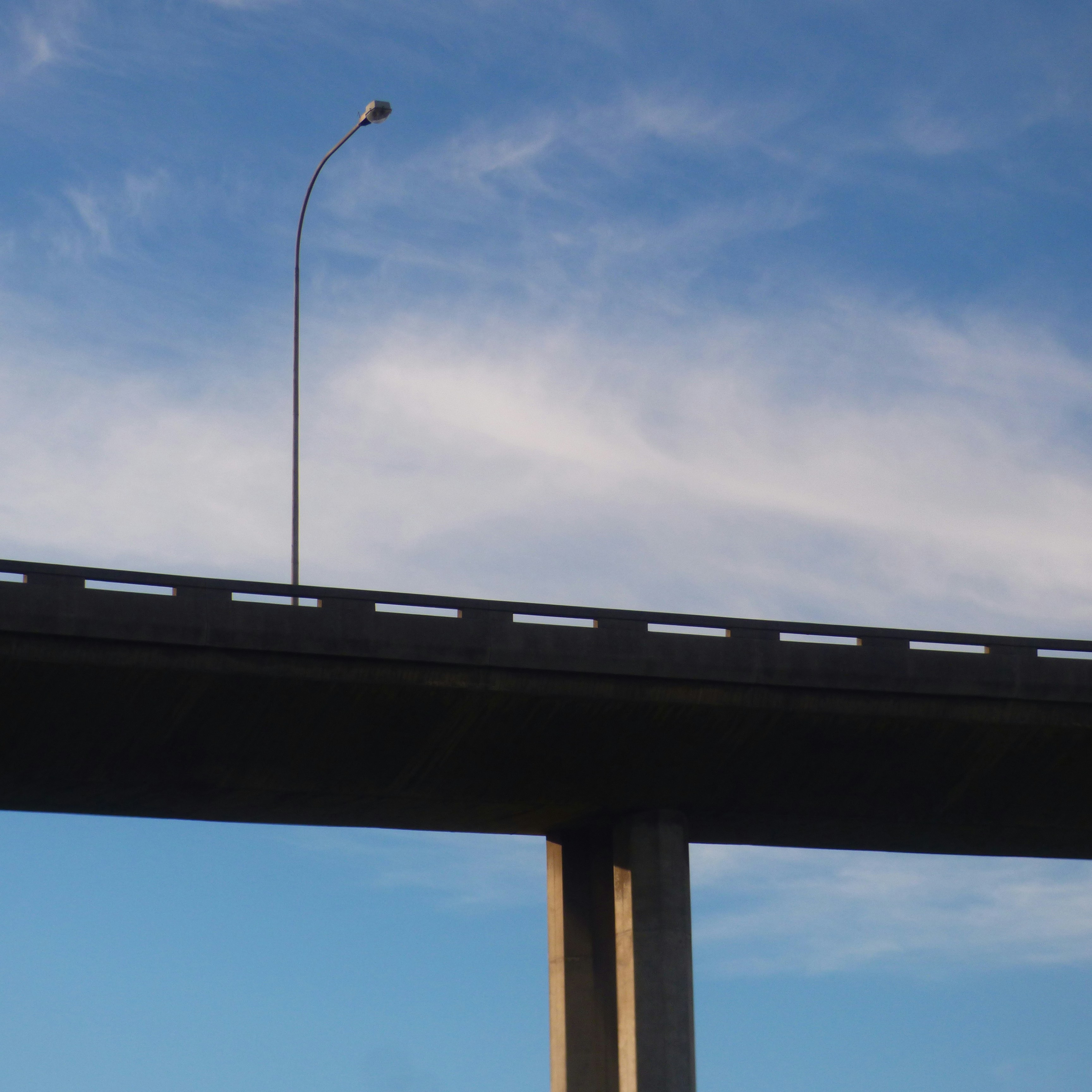 Overpass Silhouette Under a Wide Sky