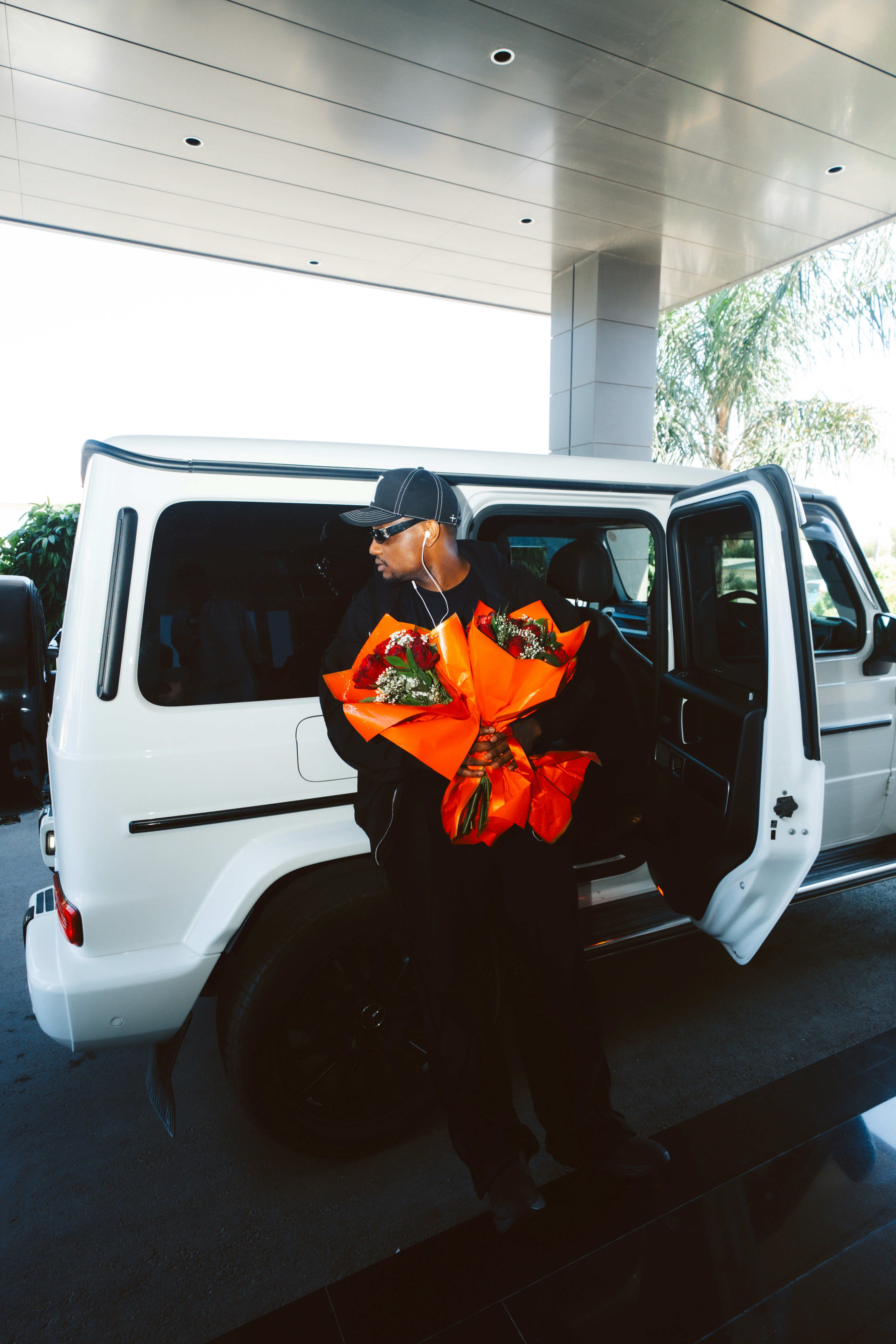 Bouquet Reveal: A Quiet Moment by the White SUV