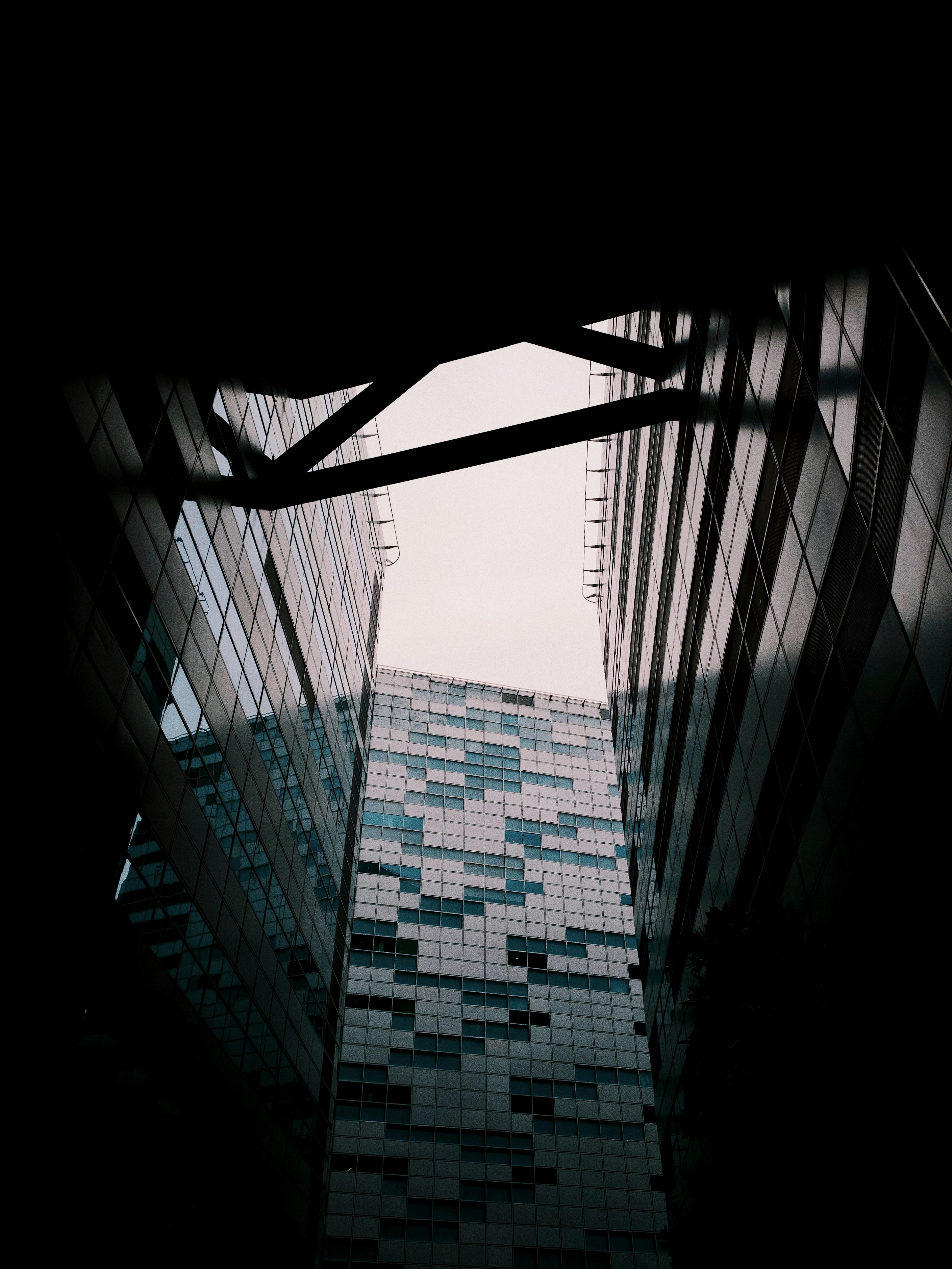 Skyward Canyon: Glass Facades Framed by Shadowed Gap