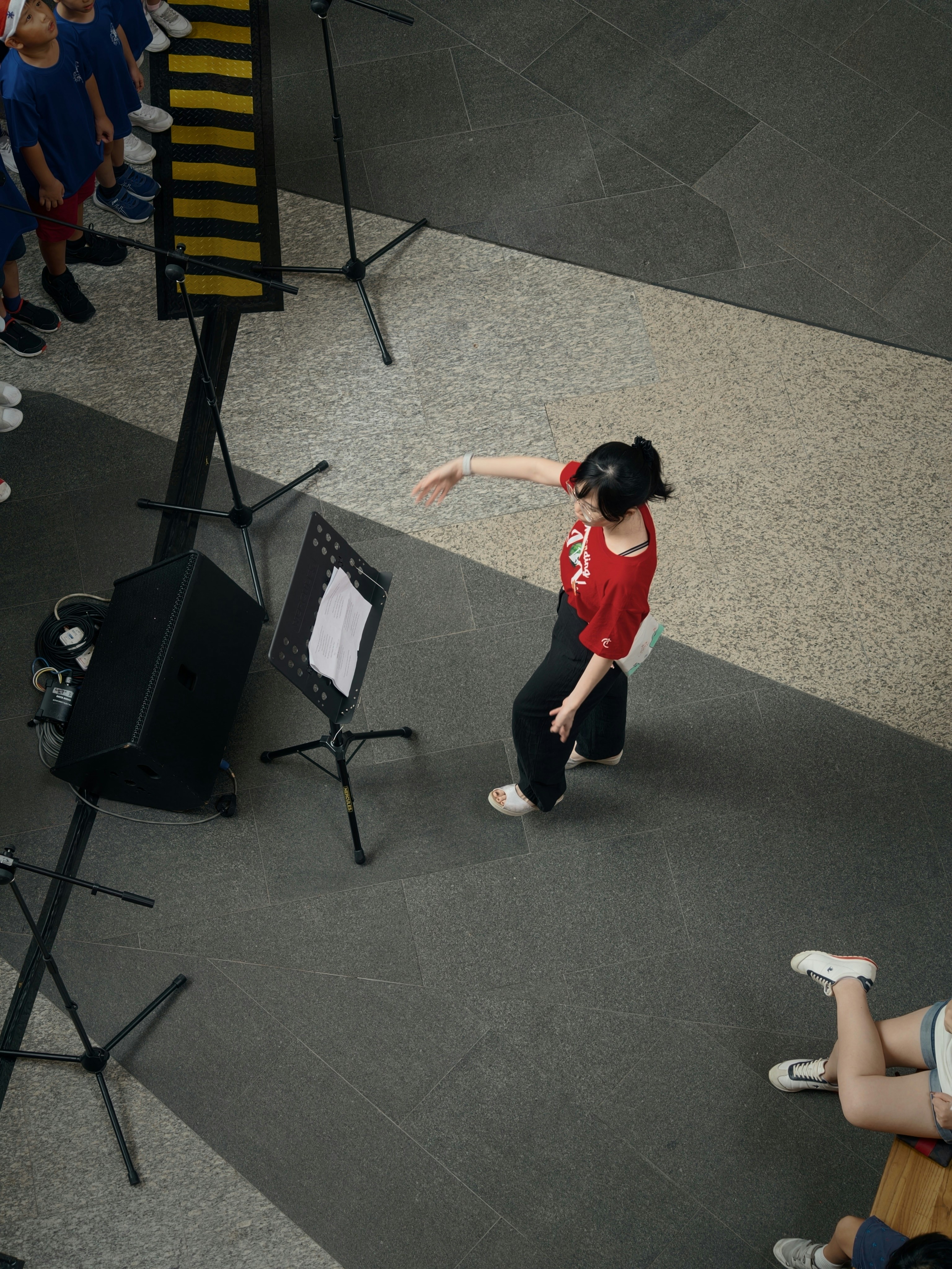 Red-clad dancer mid-movement in a spacious indoor venue