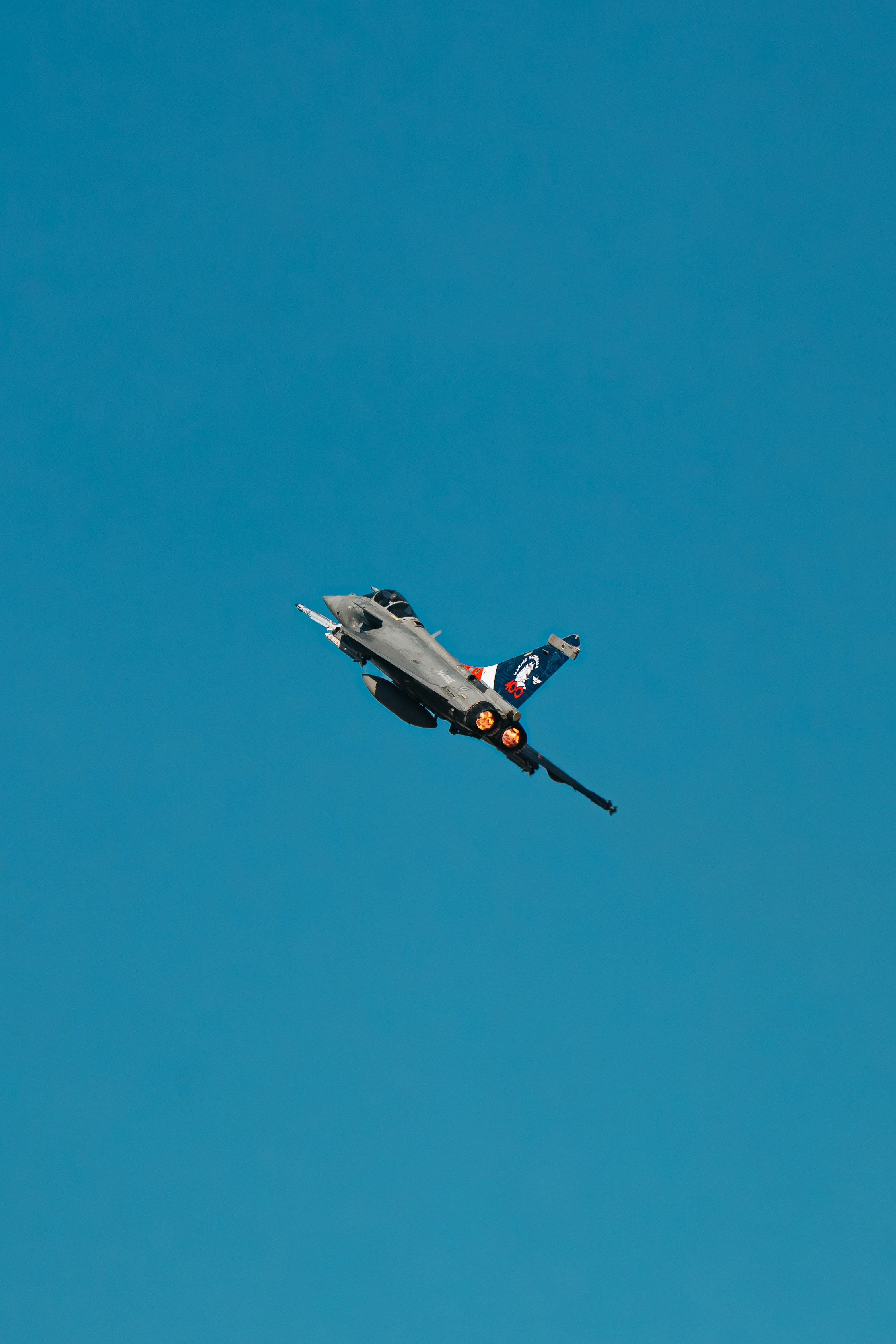 Jet in Blue: Afterburner Trace Across a Clear Sky