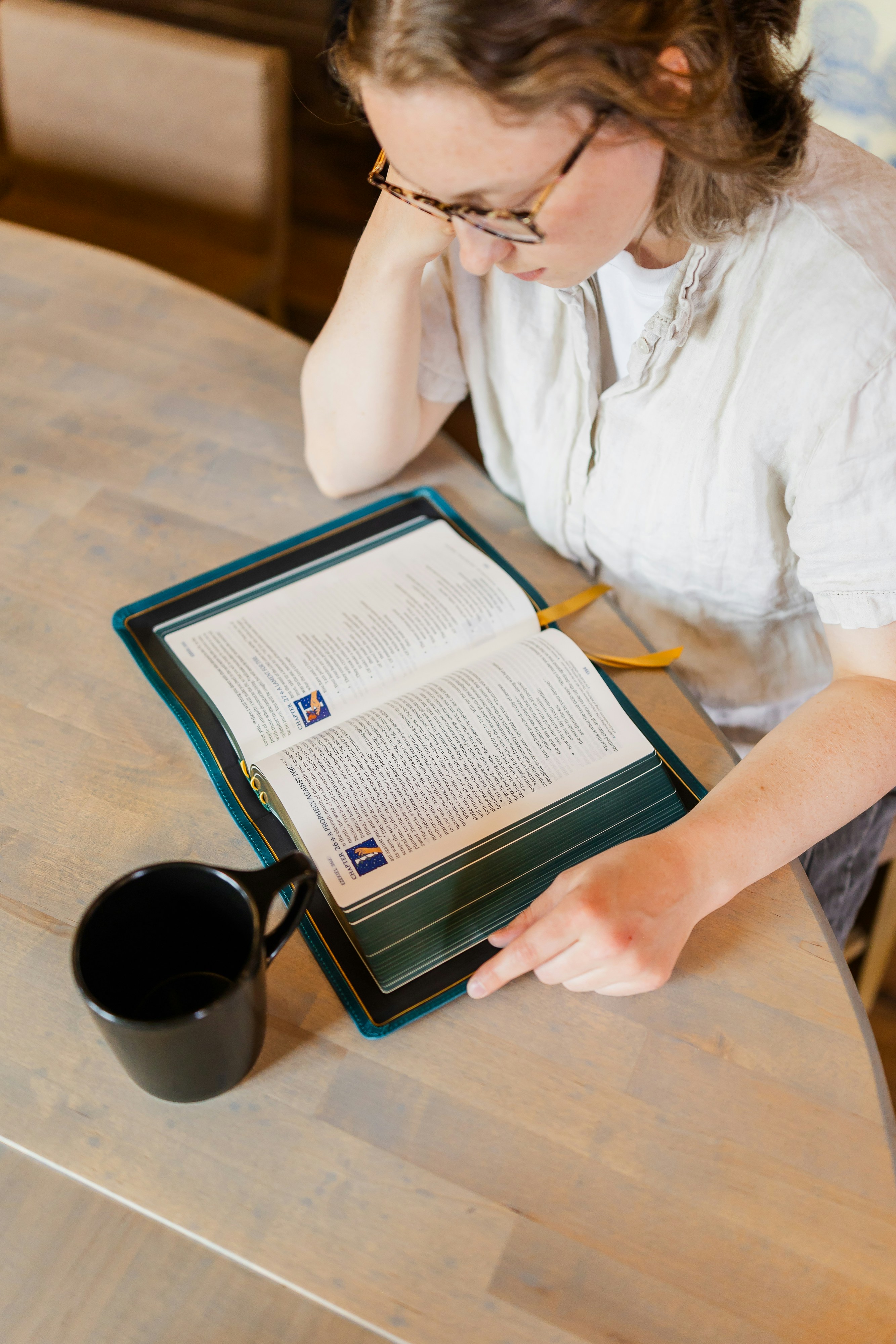 Quiet Study: A reader’s focus over a tea-stained table