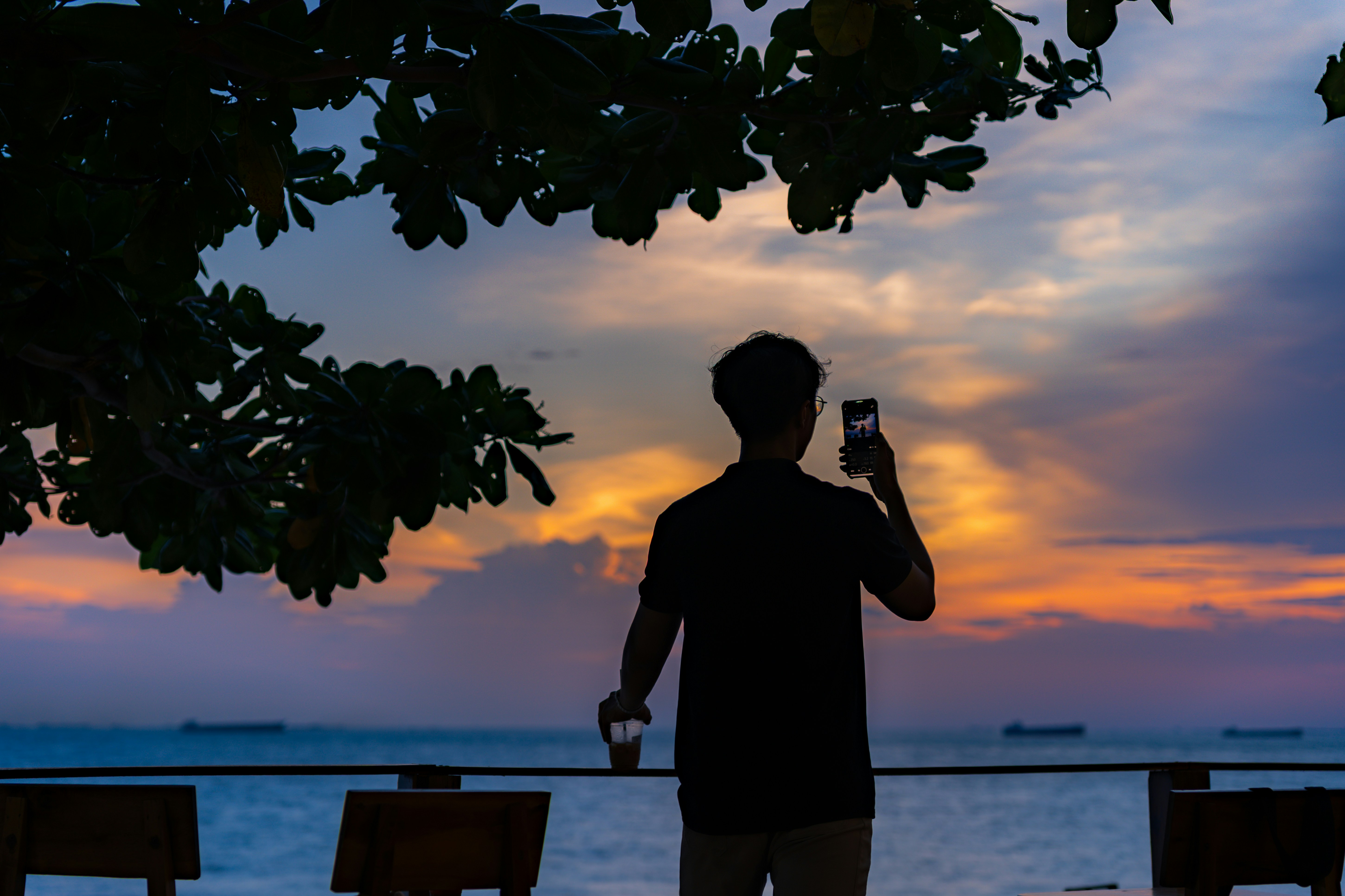 Silhouette at Dusk: The Photographer Framing the Horizon