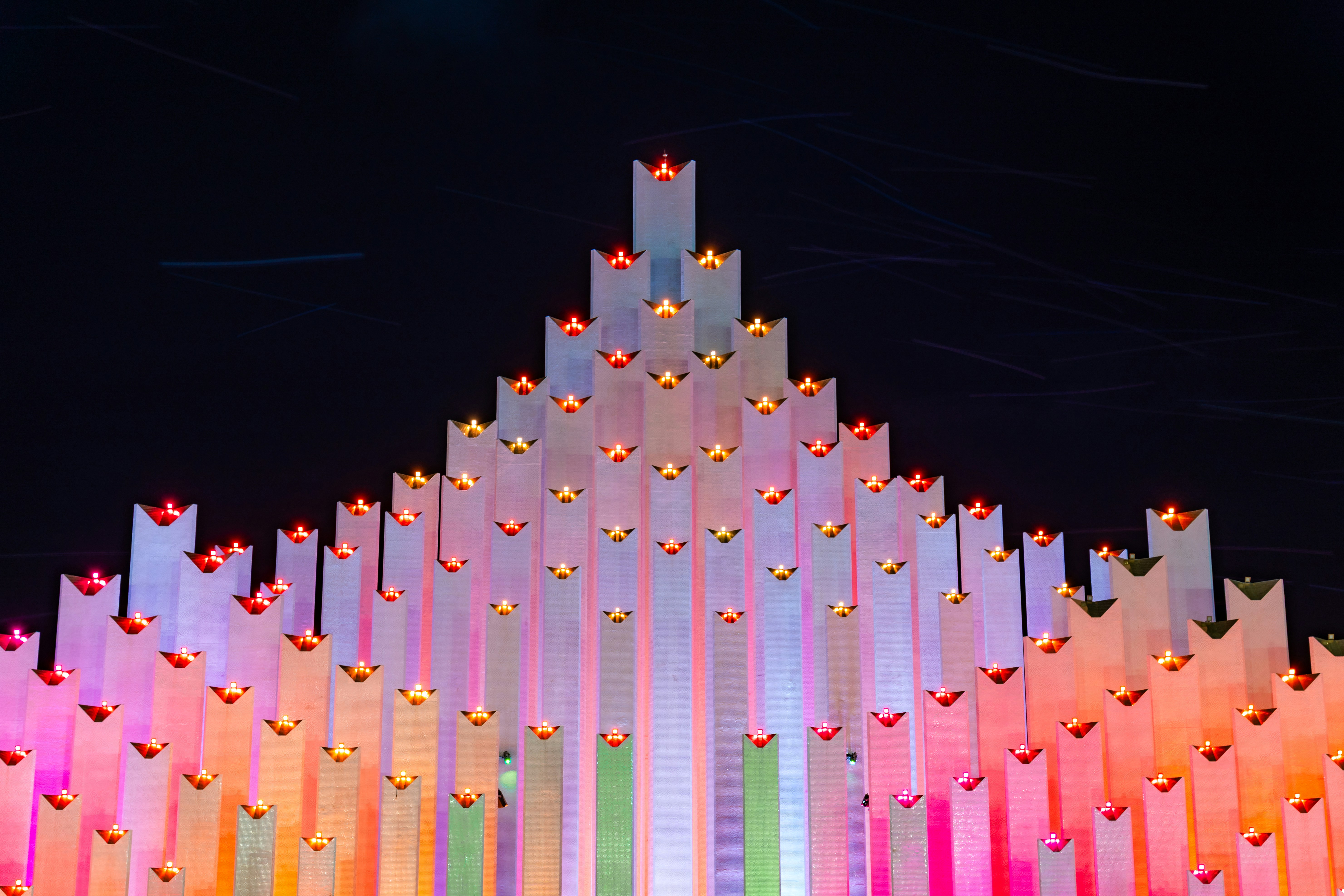 Chromatic Pyramid: Neon Columns Rise at Night