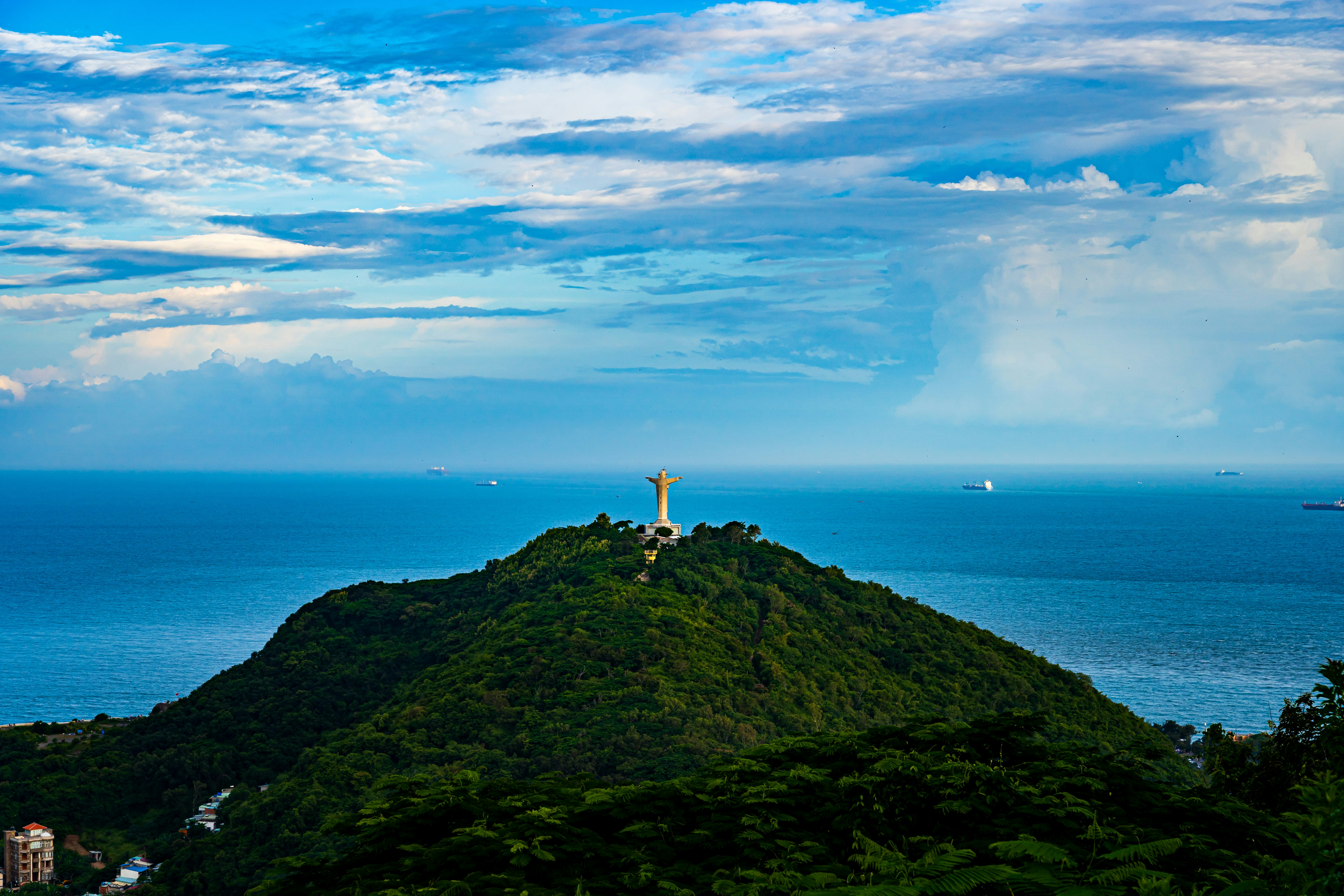 Hilltop Monument over Verdant Prominence against a Sea Horizon