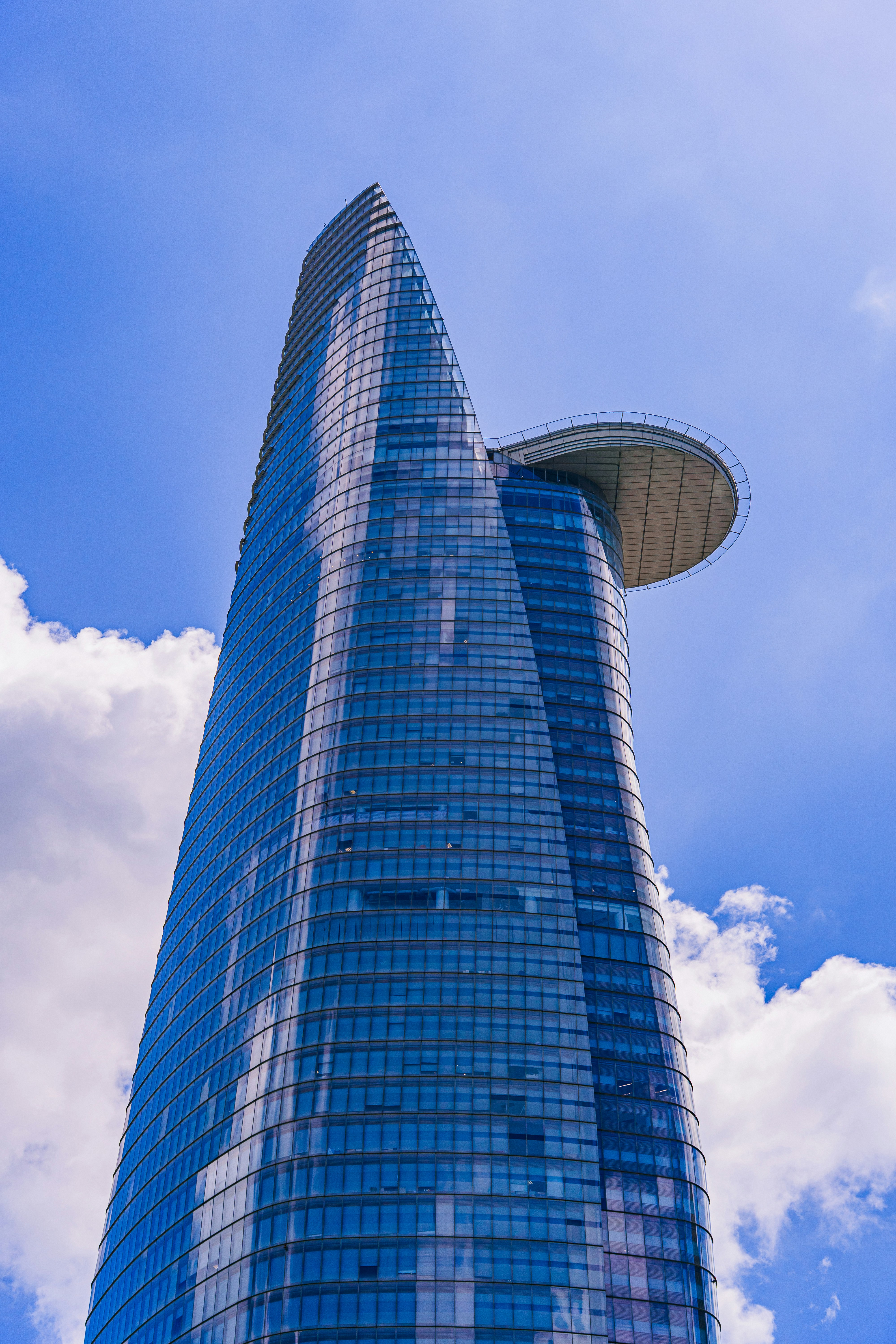 Skyward Curve: The Intense Rise of a Glass-Blue Tower