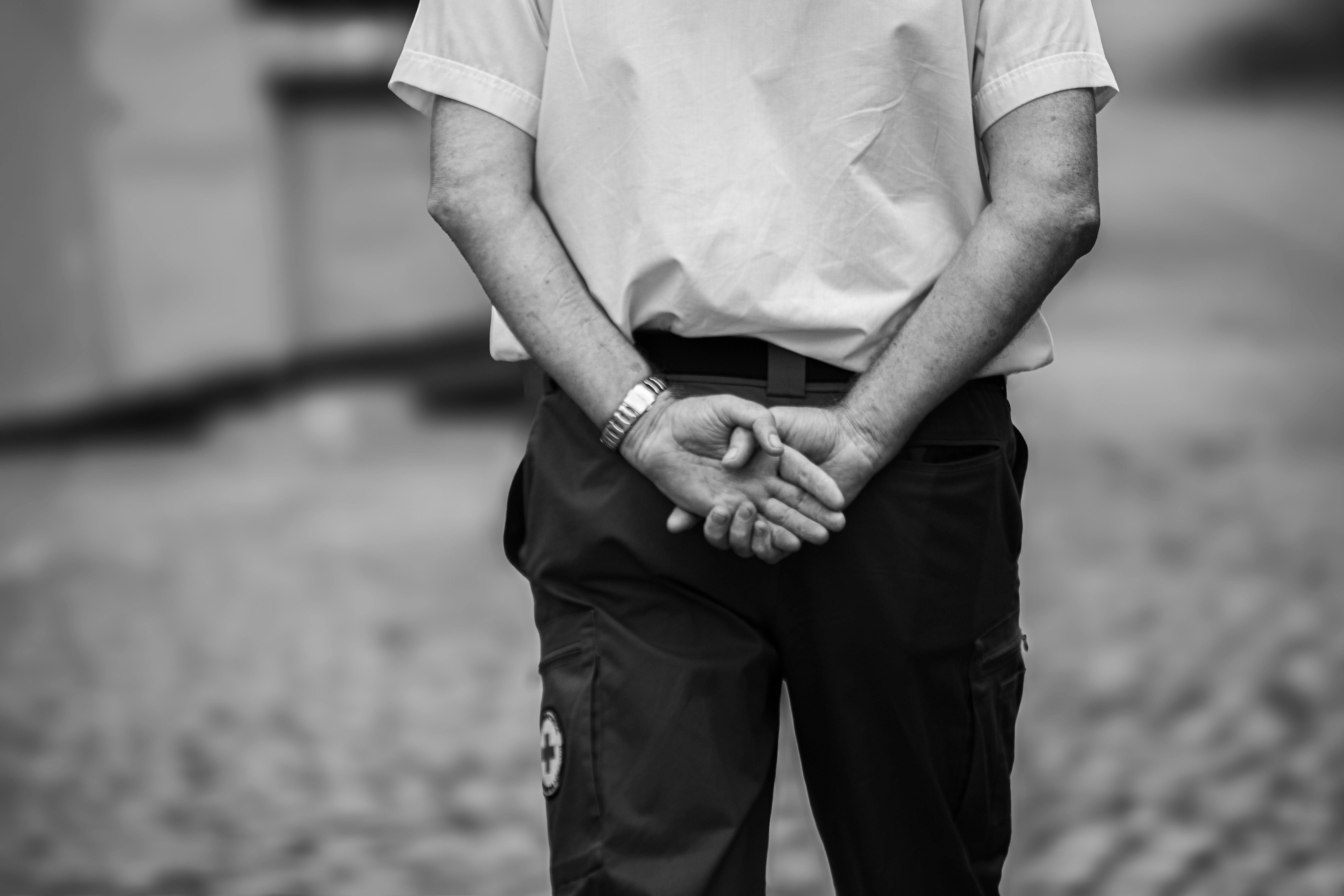 Hands Behind the Back: A Quiet Stance in a Monochrome Moment