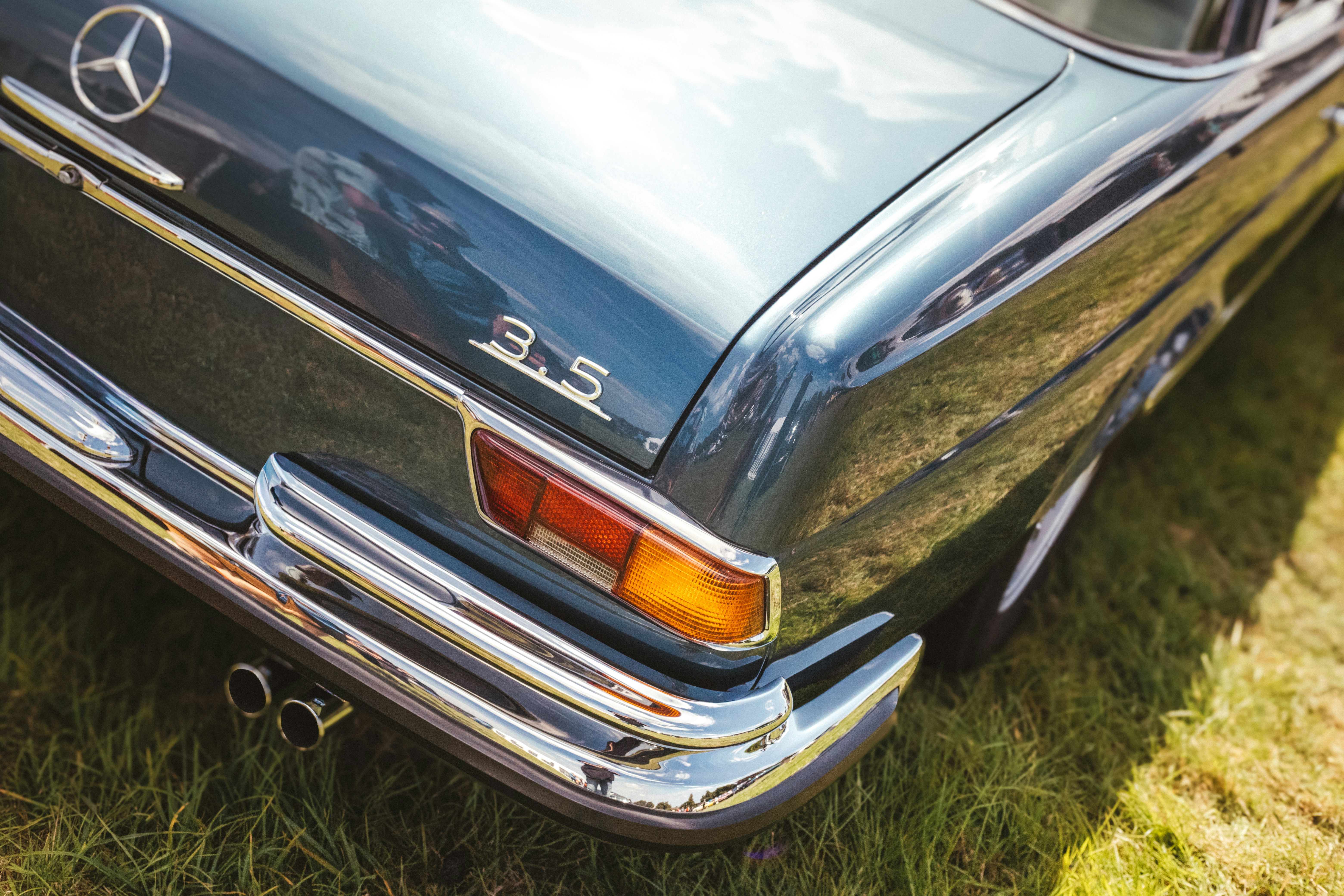 Chrome and Carriage: The Gentle Curves of a Classic Mercedes in Sunlit Grass