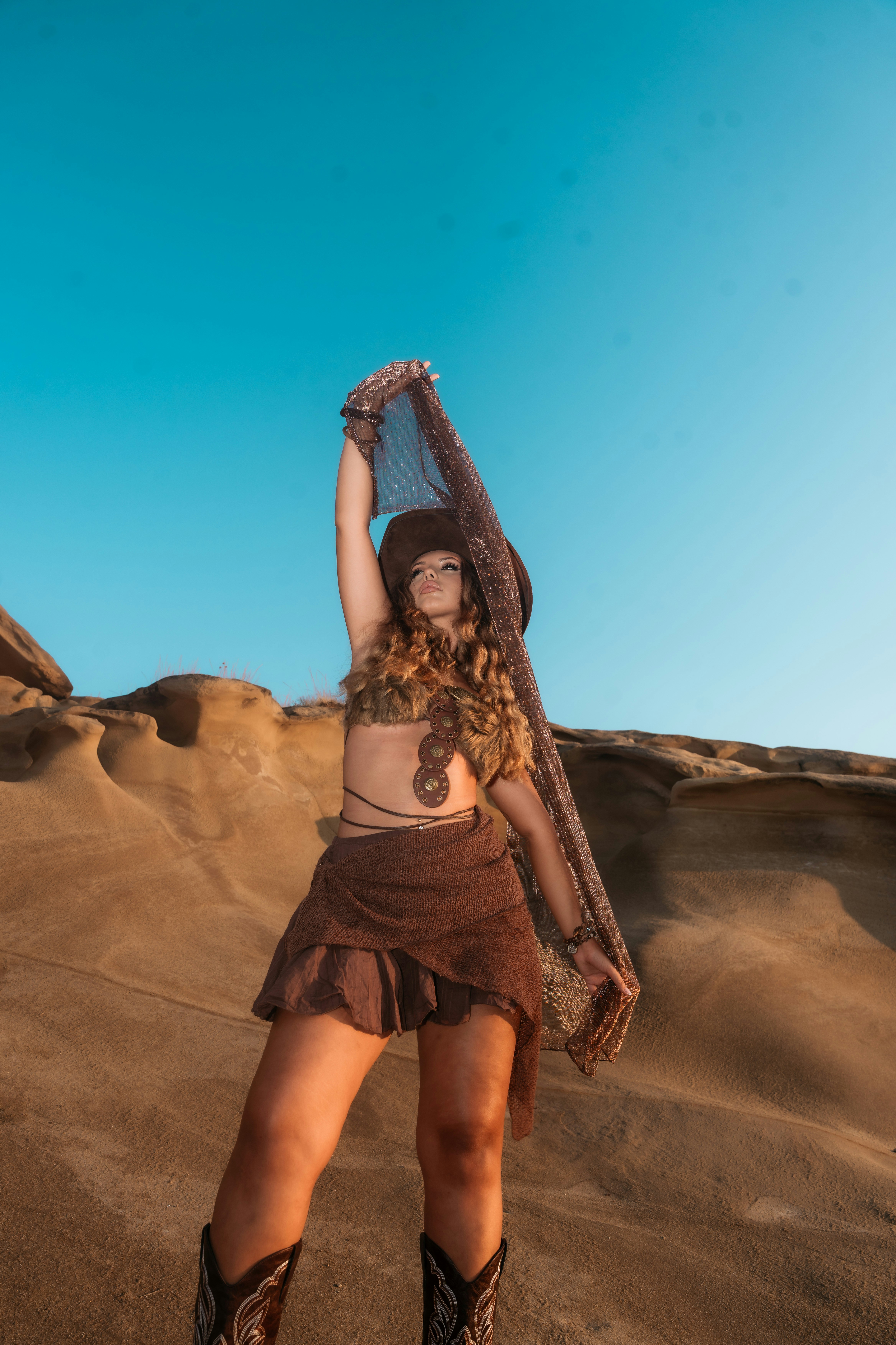 Desert Gypsy: A Sunlit Pose Amid Dune Waves