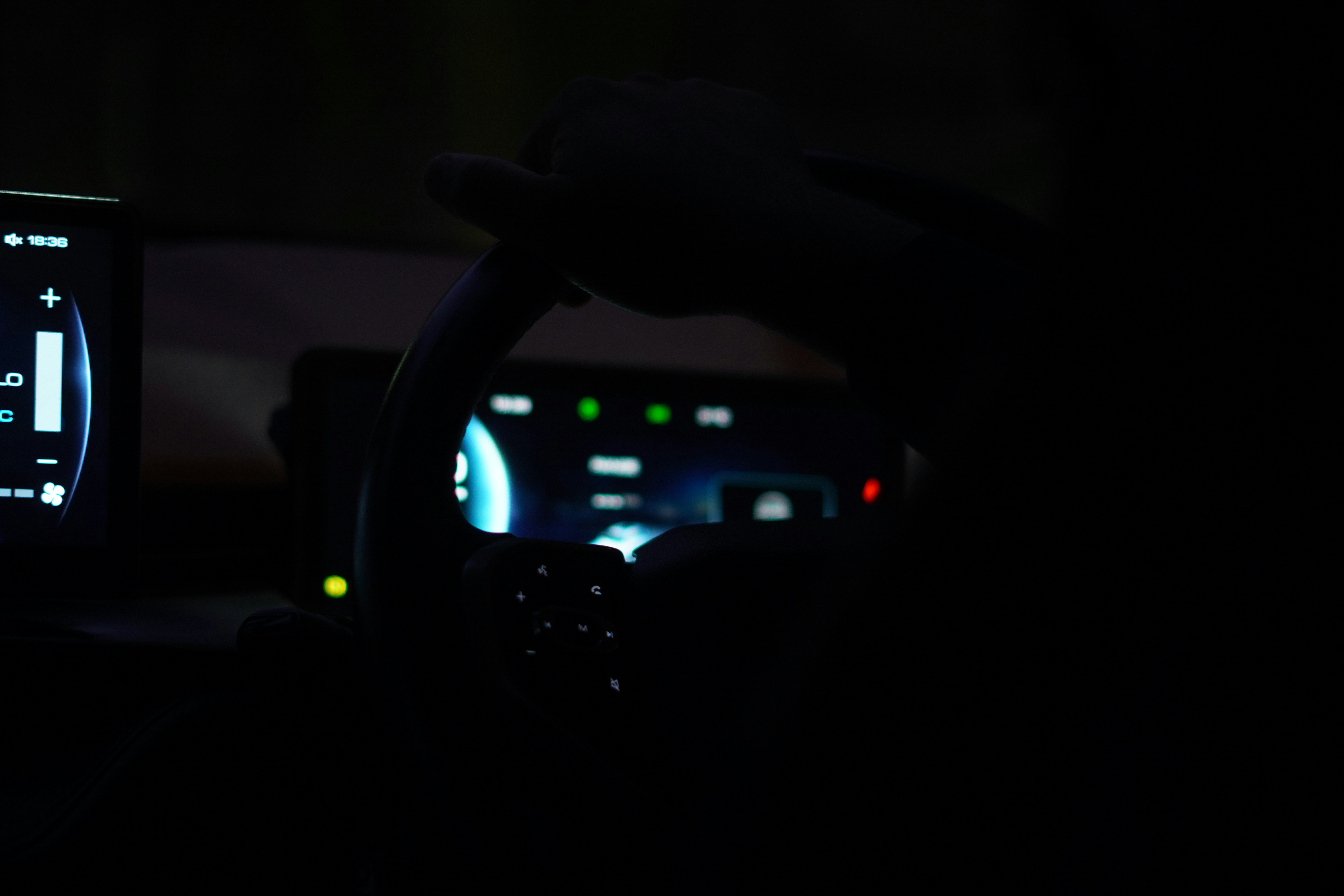 Dimly Lit Dashboard: Steering Wheel and Digital Glow