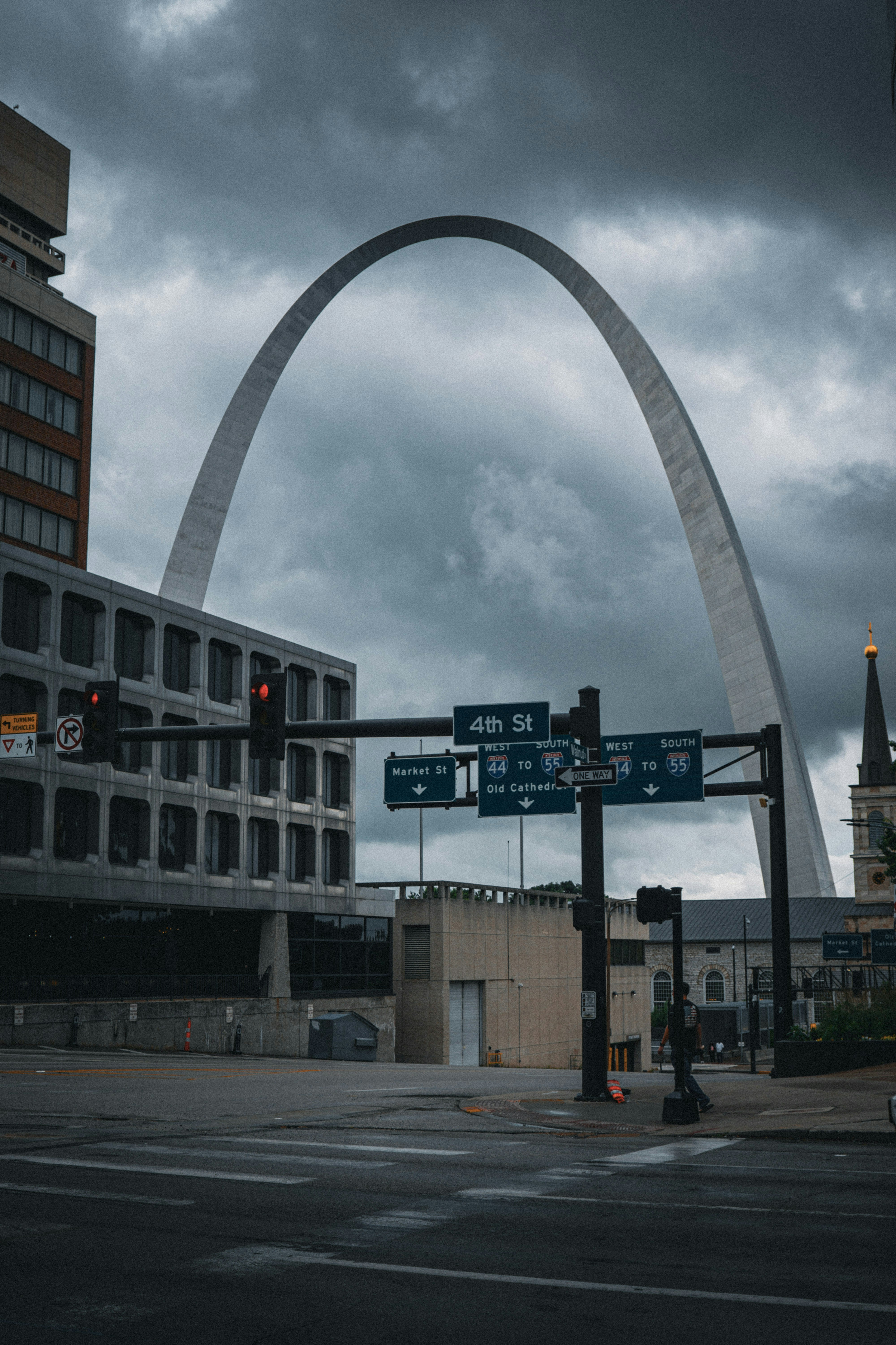 Streak of Steel: The Gateway Arch Framed by Stormy City Streets