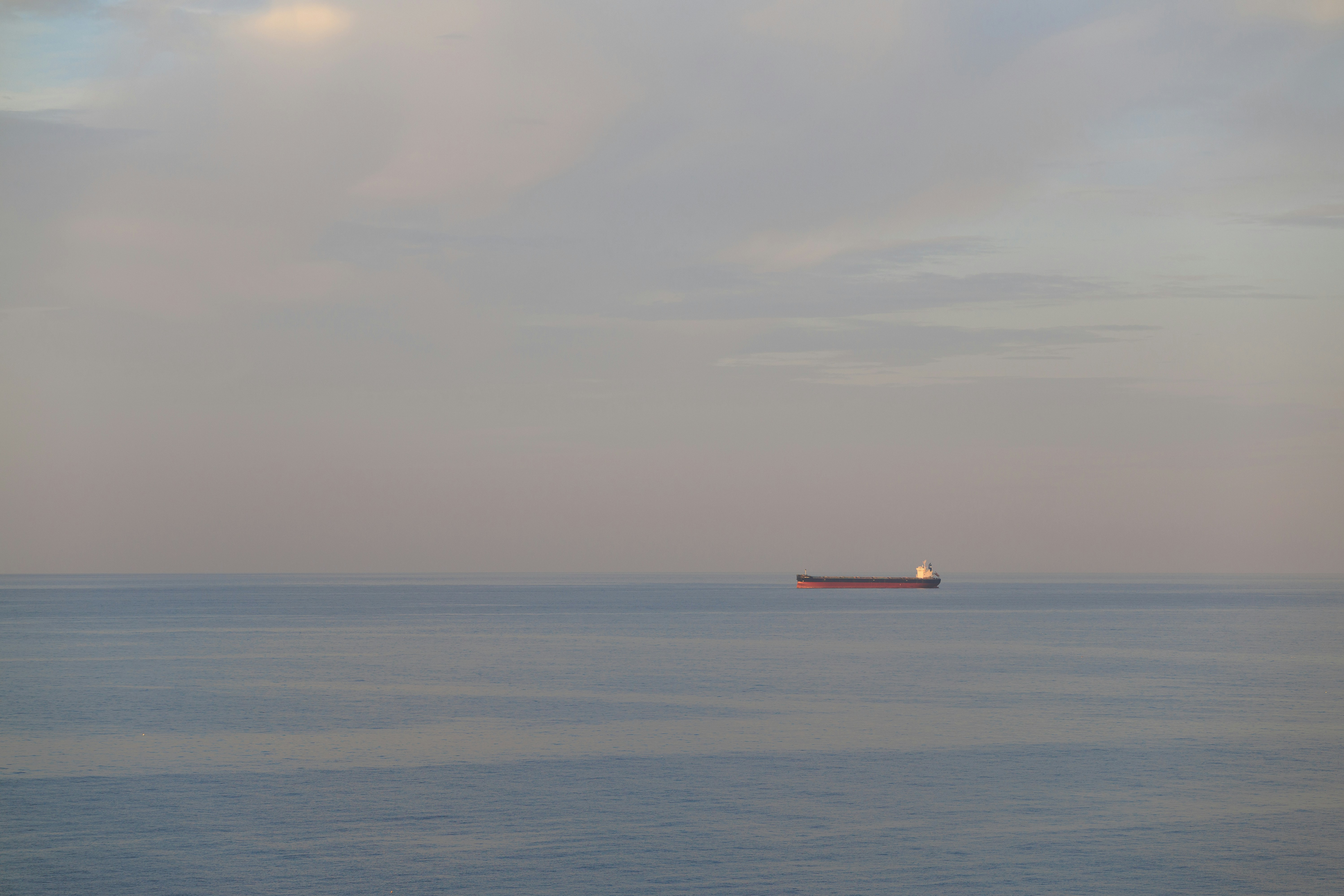Horizon Vessel: A Distant Cargo Ship on Calm Seas