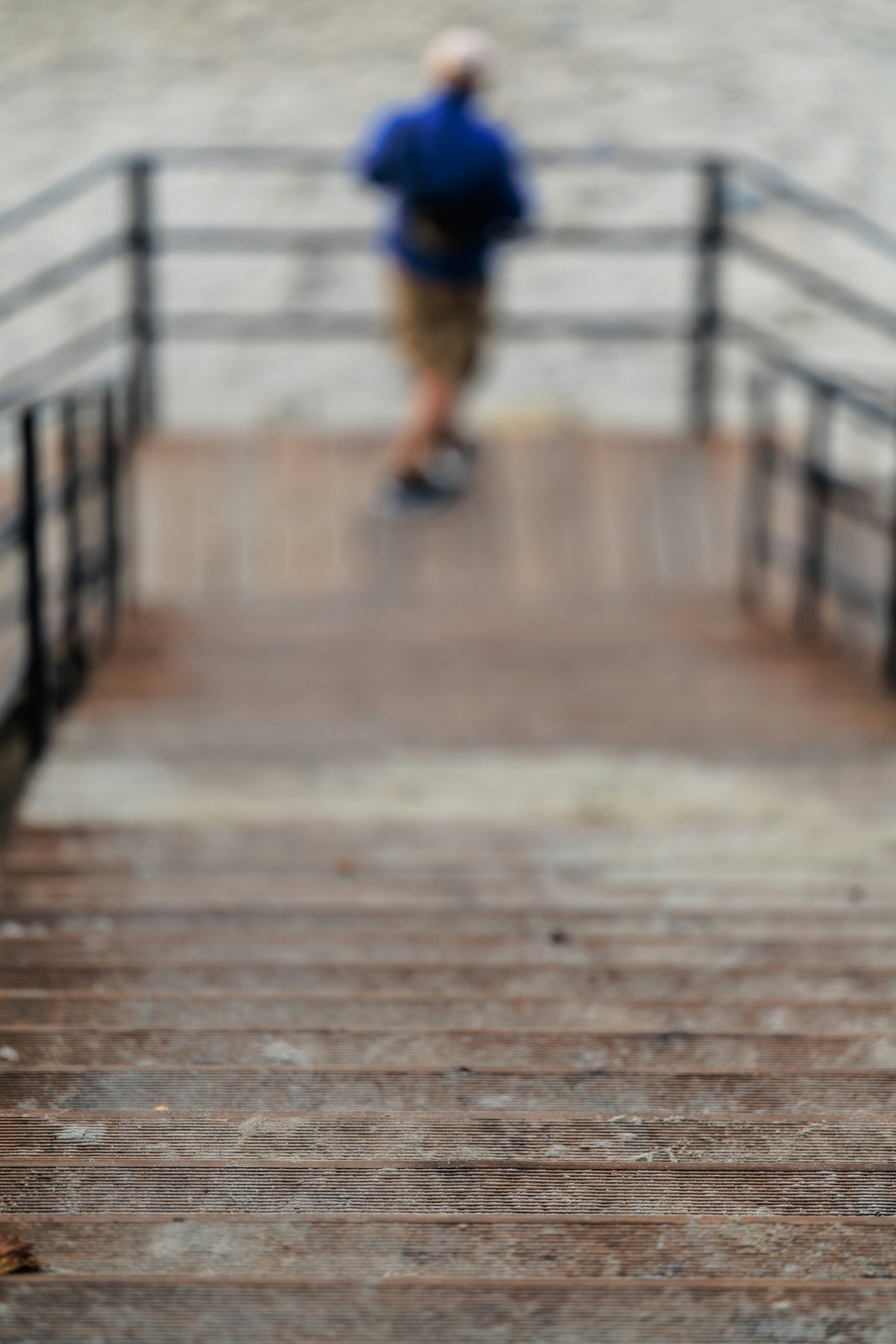 Distant Runner on a Weathered Pier