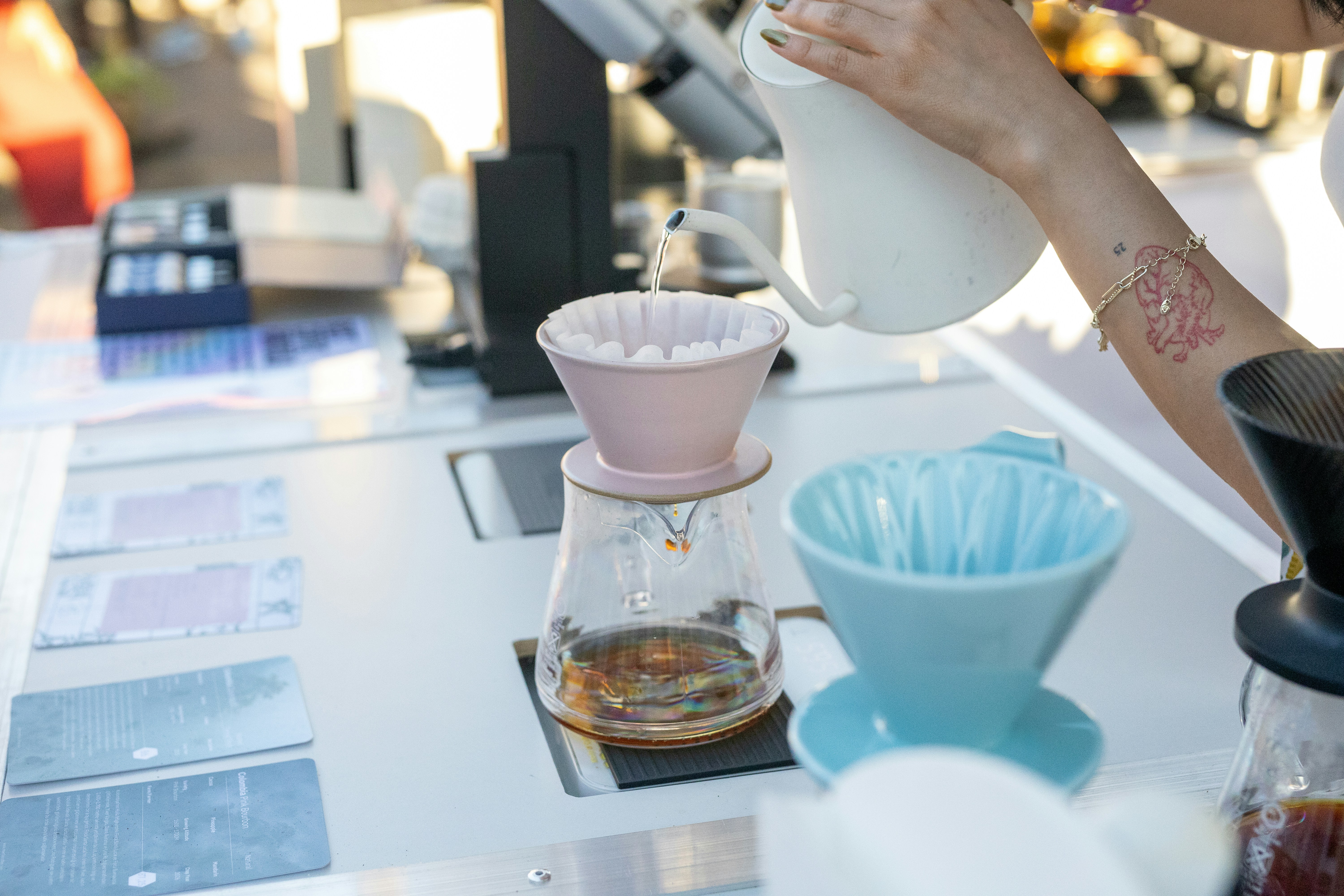 Pouring ritual at a coffee bar: a pour-over station in daylight