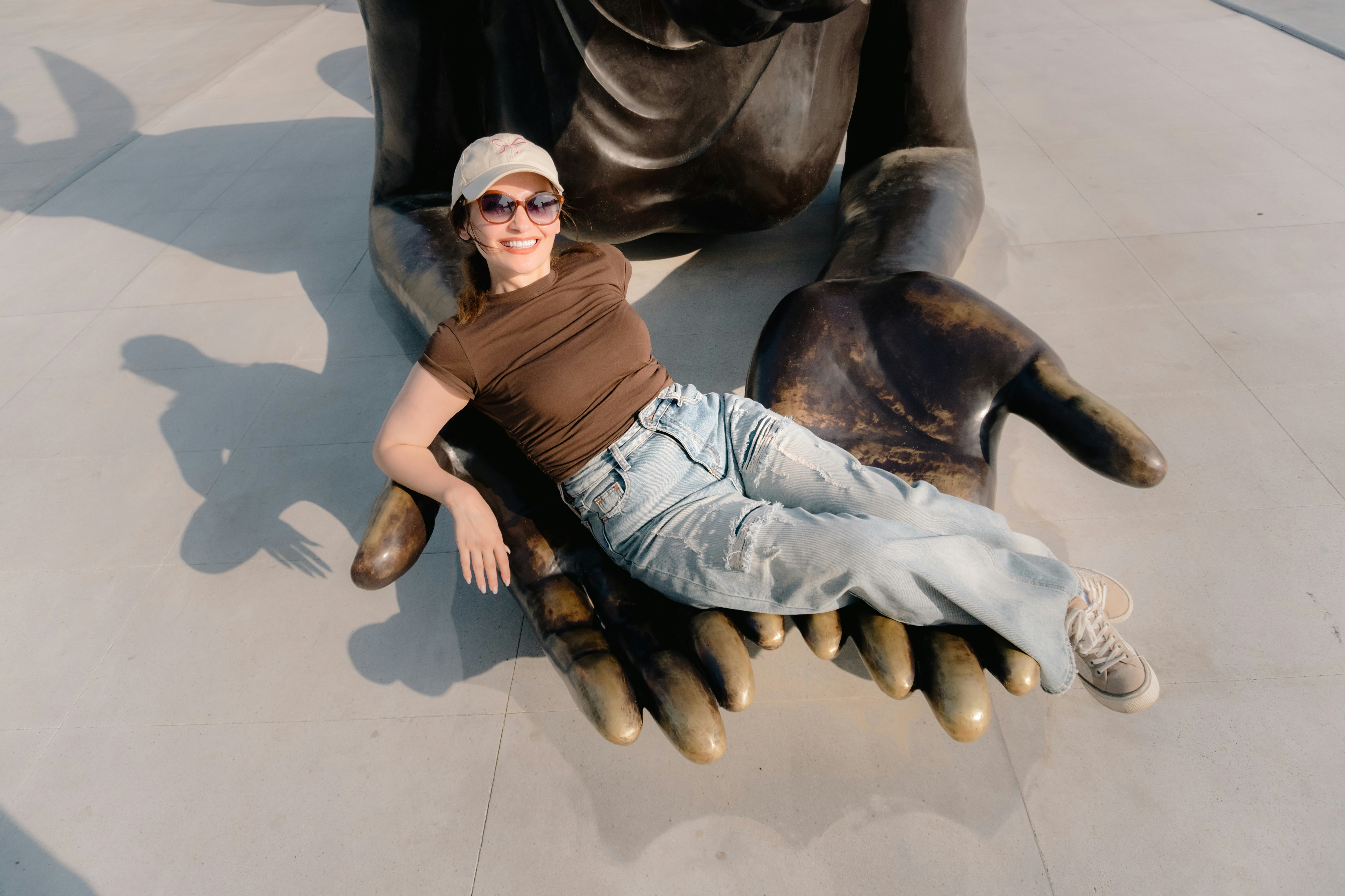Relaxed at the Giant's Palm: A Casual Lean on a Sculpted Hold