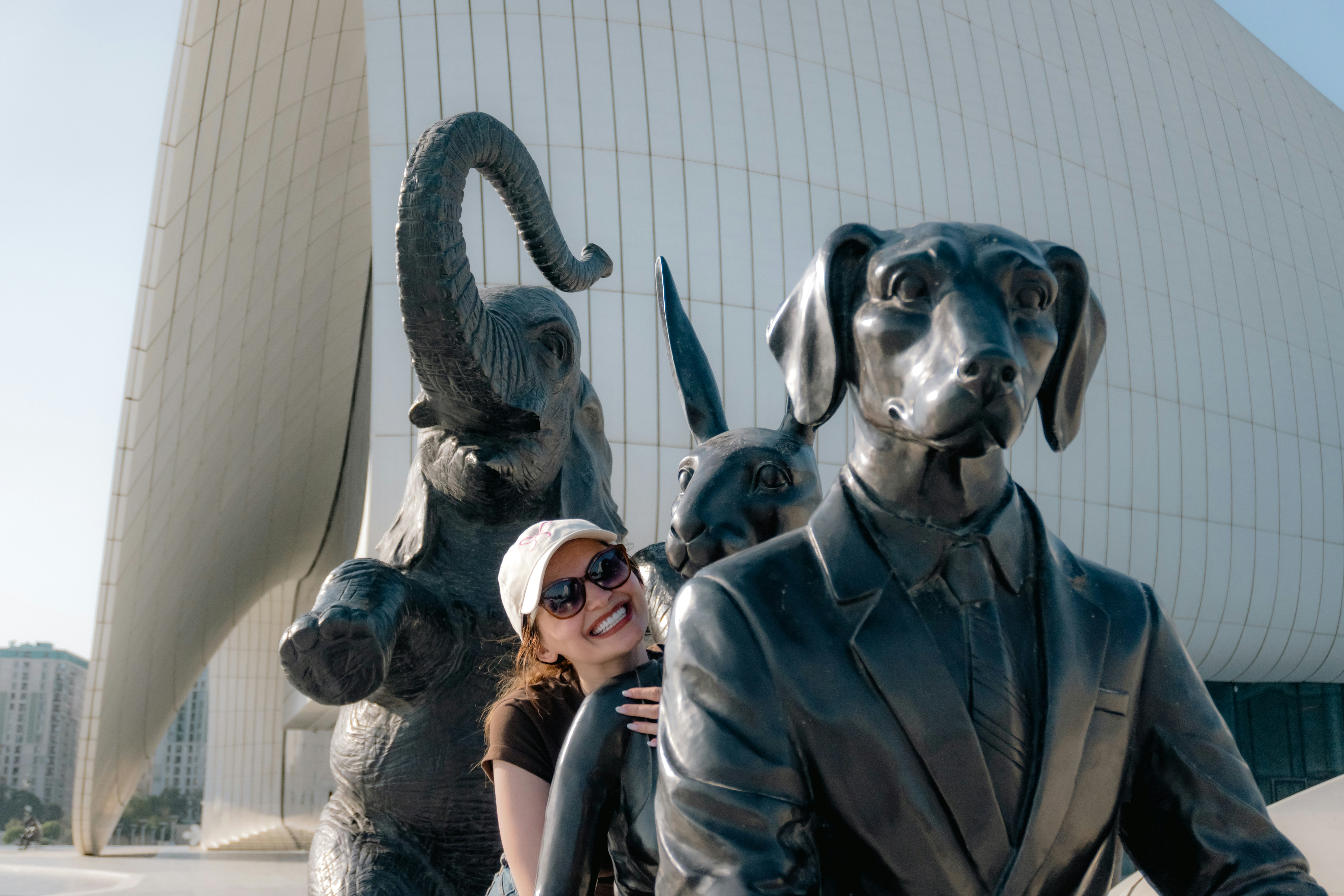 Hidden Smile Among Giants: Portrait with Weathered Statues at the Museum