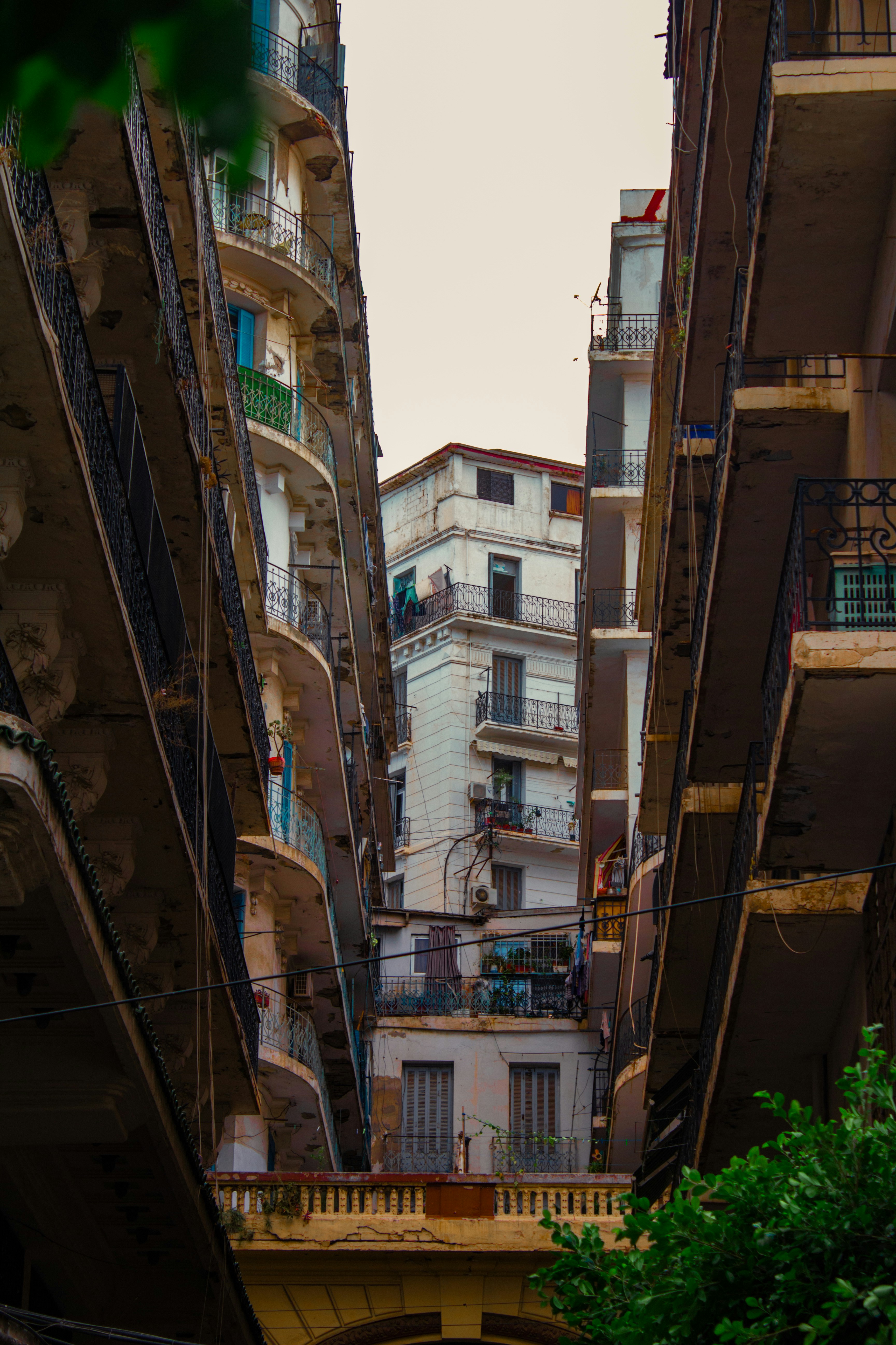 Between Weathered Facades: A Narrow Urban Corridor Framing Light at the End