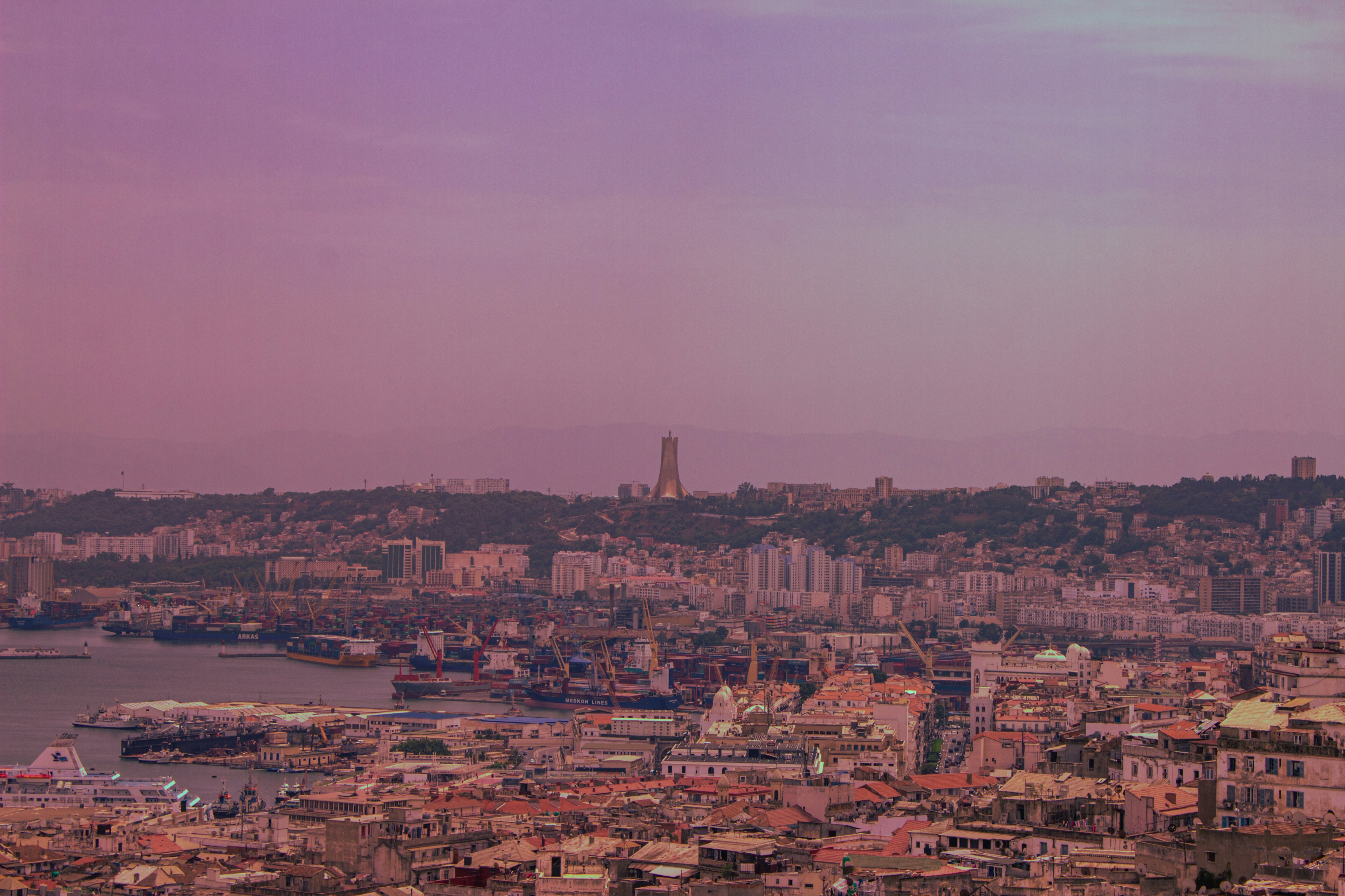 Sunset Over a Historic Harbor: Quiet Horizons above a Contoured Cityscape