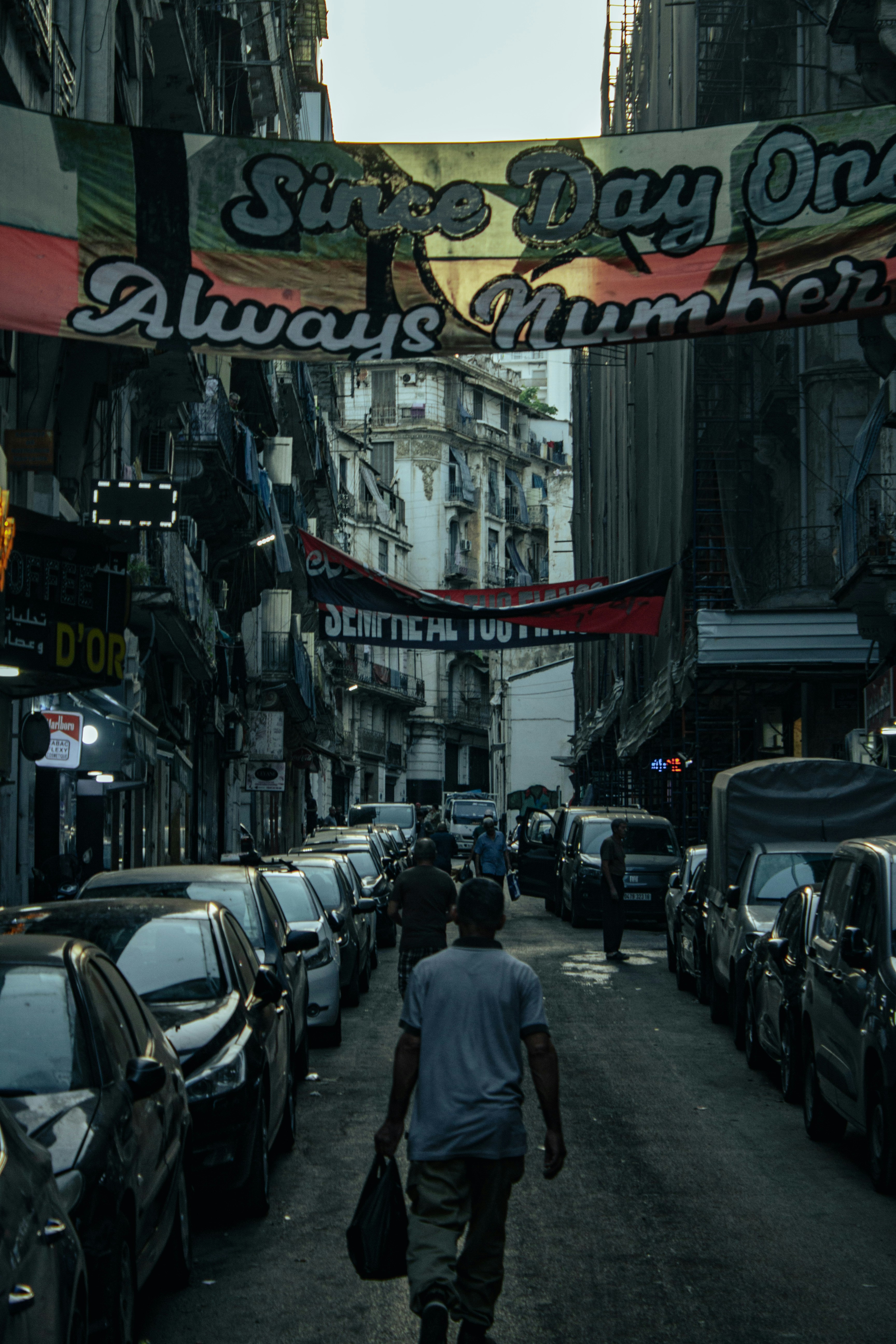 Street Banner Over Narrow Alleyway: A Walk Through the Dusk Market