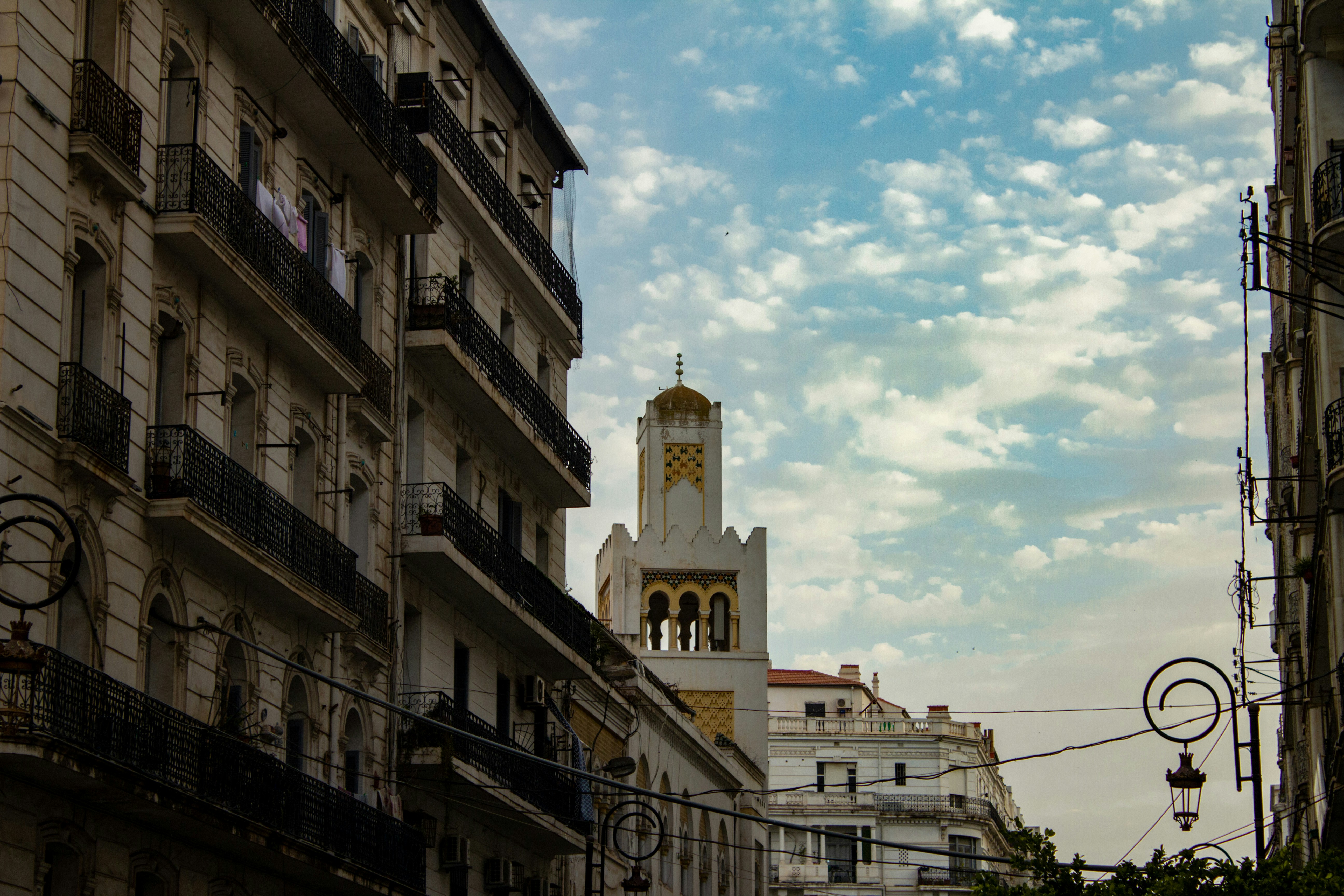 Towering Clock Cupola Rising Between Two Streets