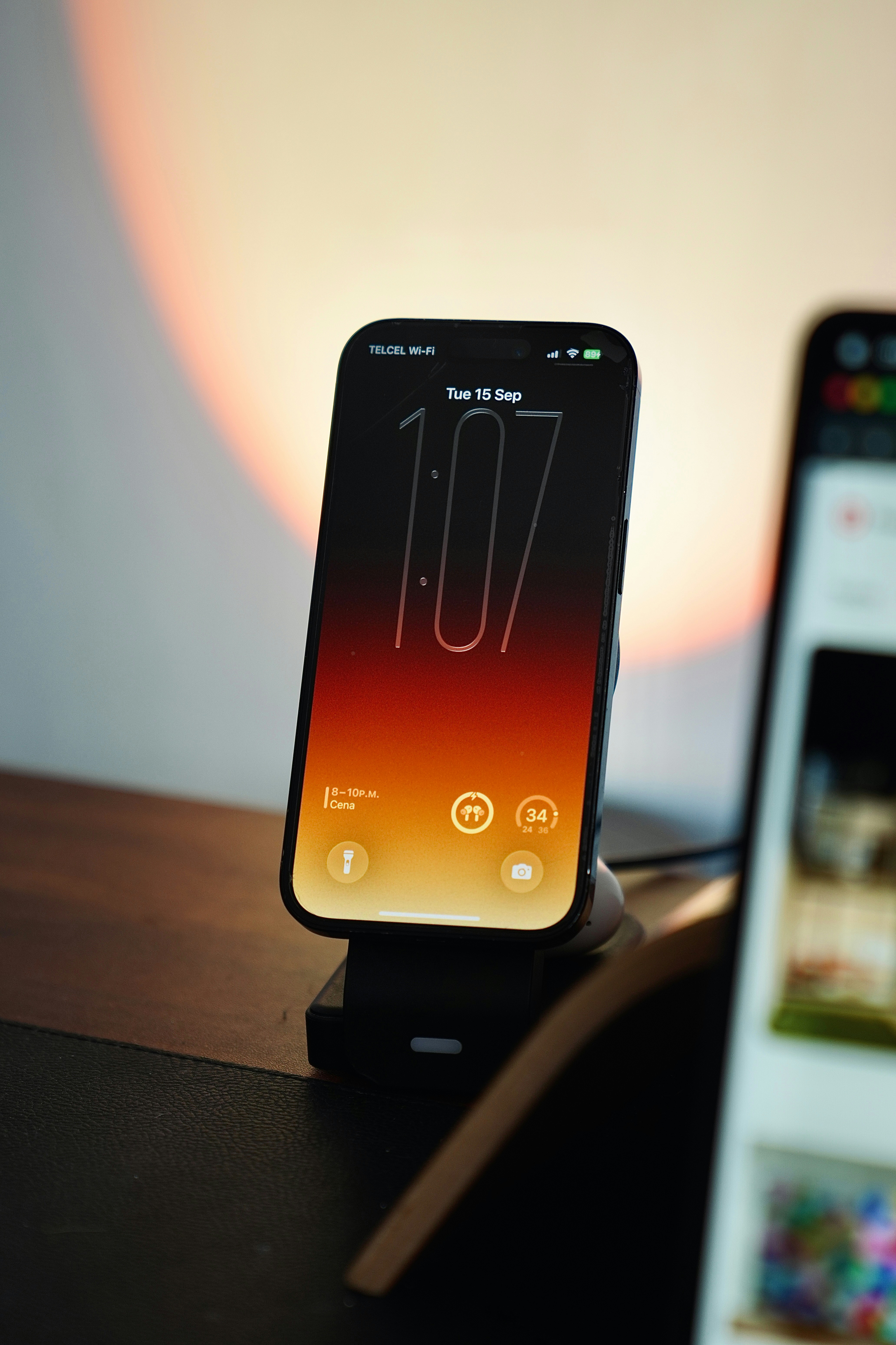 Glowing iPhone on a desk glow with gradient wallpaper