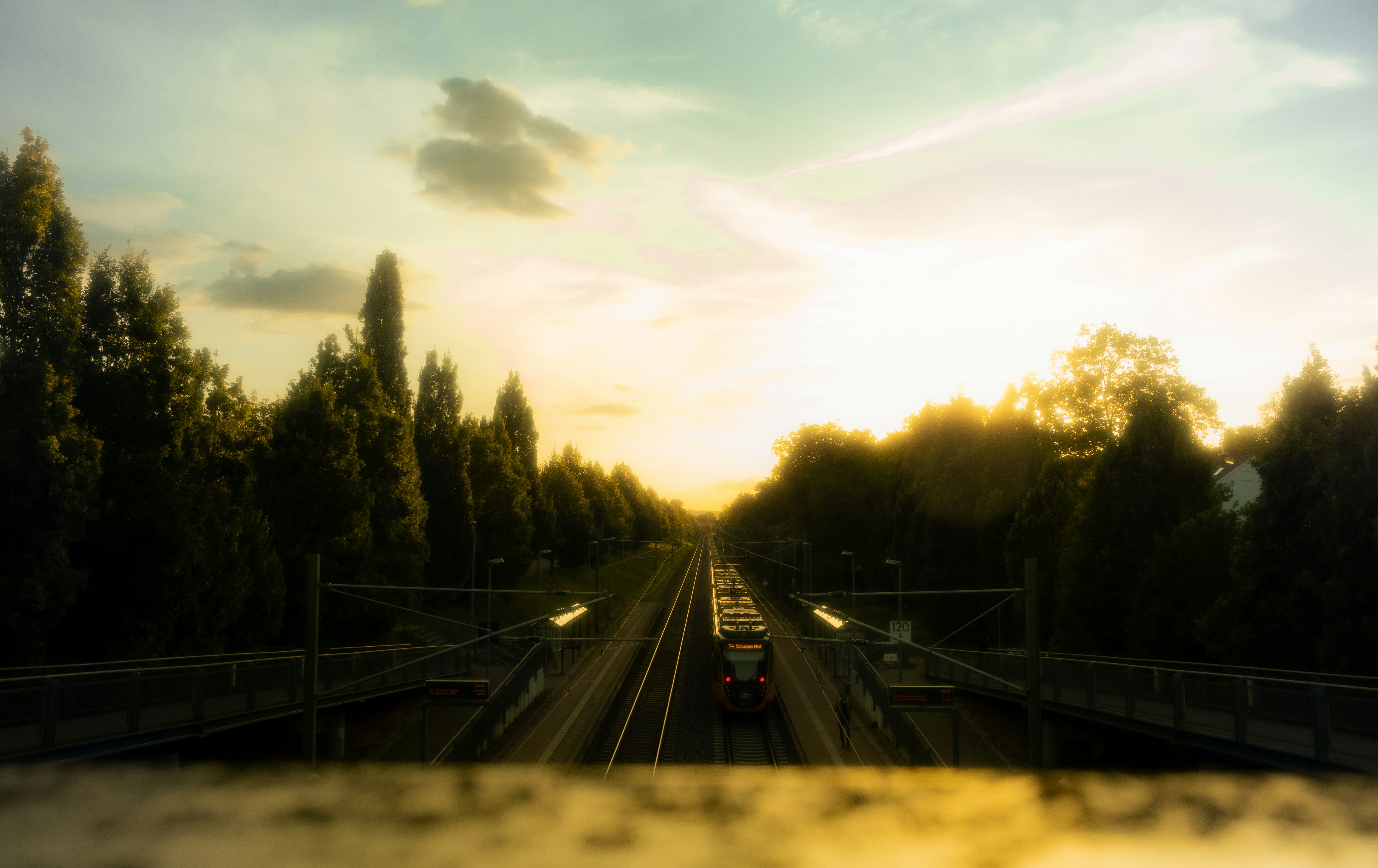 Toward the Glowing Horizon: A Rail Line Vanishing into the Sunset
