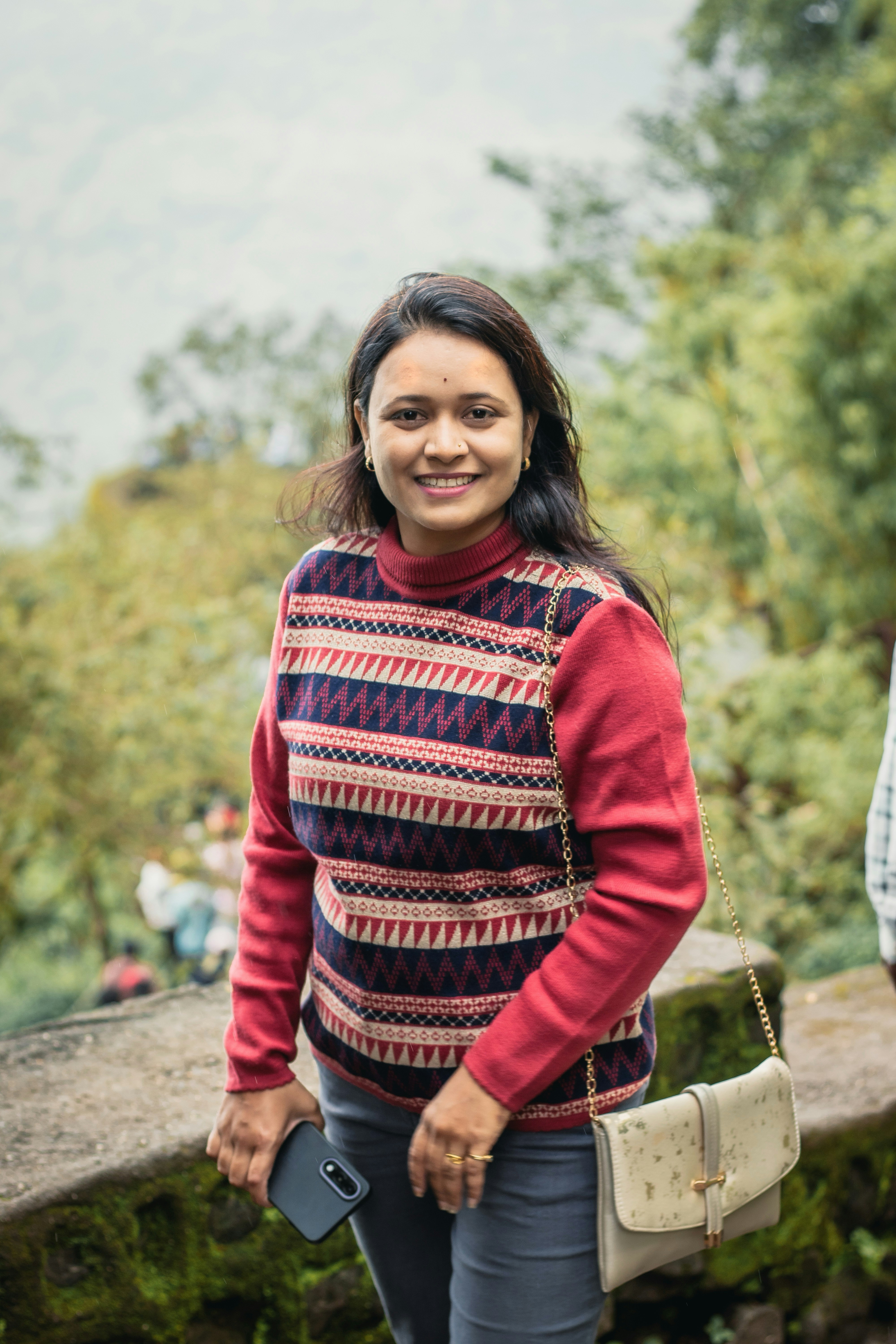 Smiling Portrait in a Cozy Knitwear Amid Nature