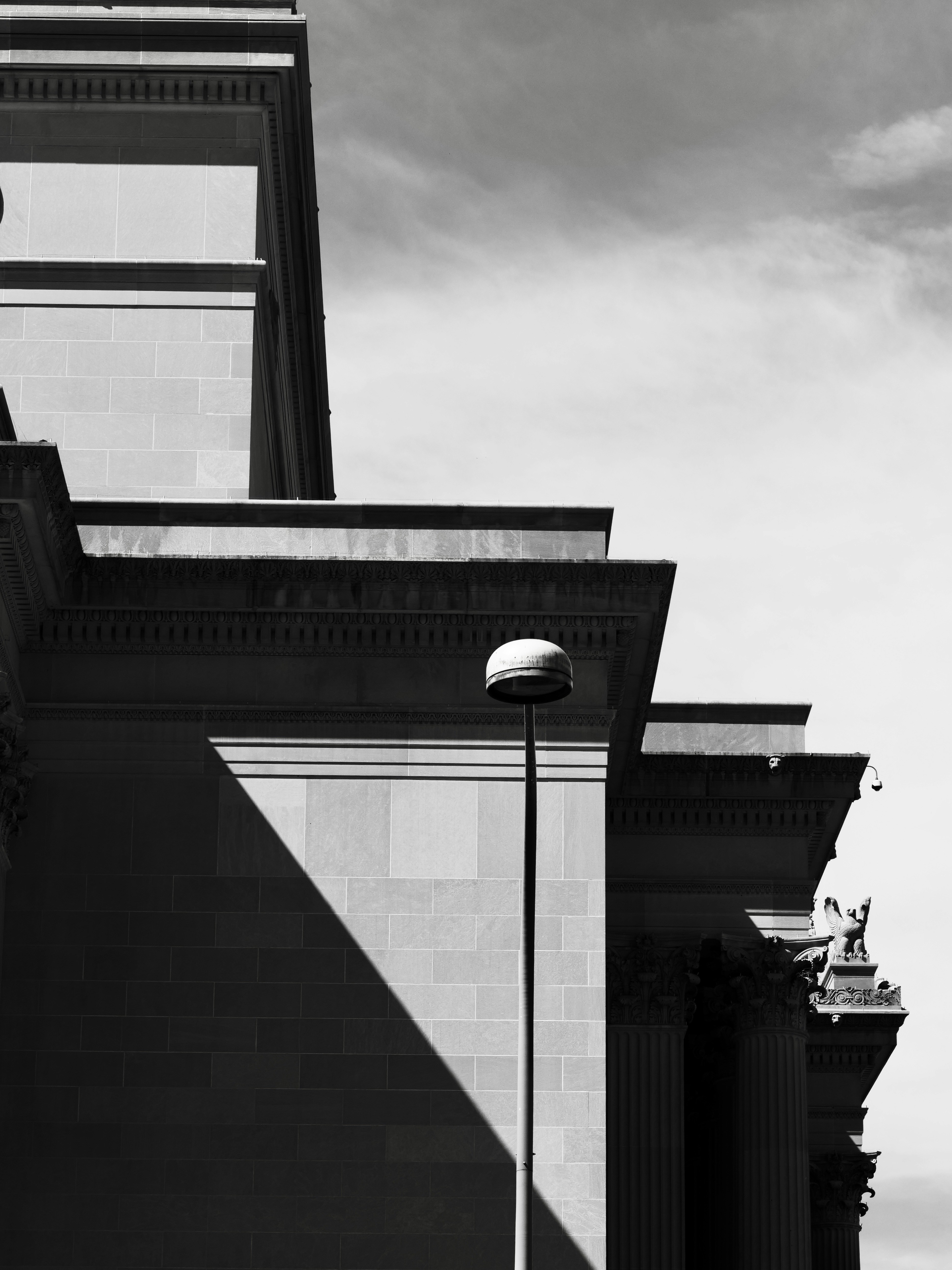 A classicist building with a street lamp