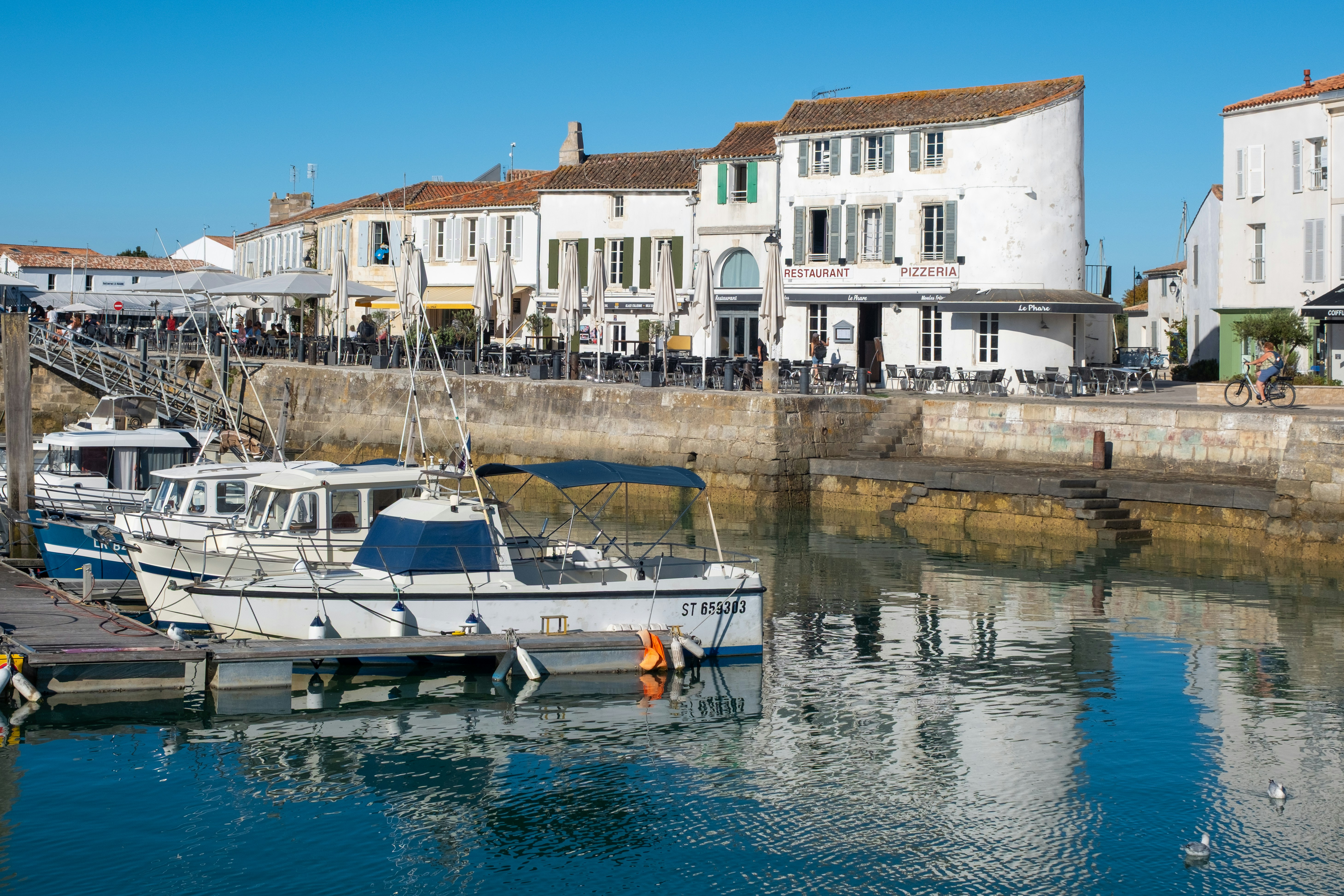 Harbor Quiet: Boats, Water, and a Row of White-Washed Shops