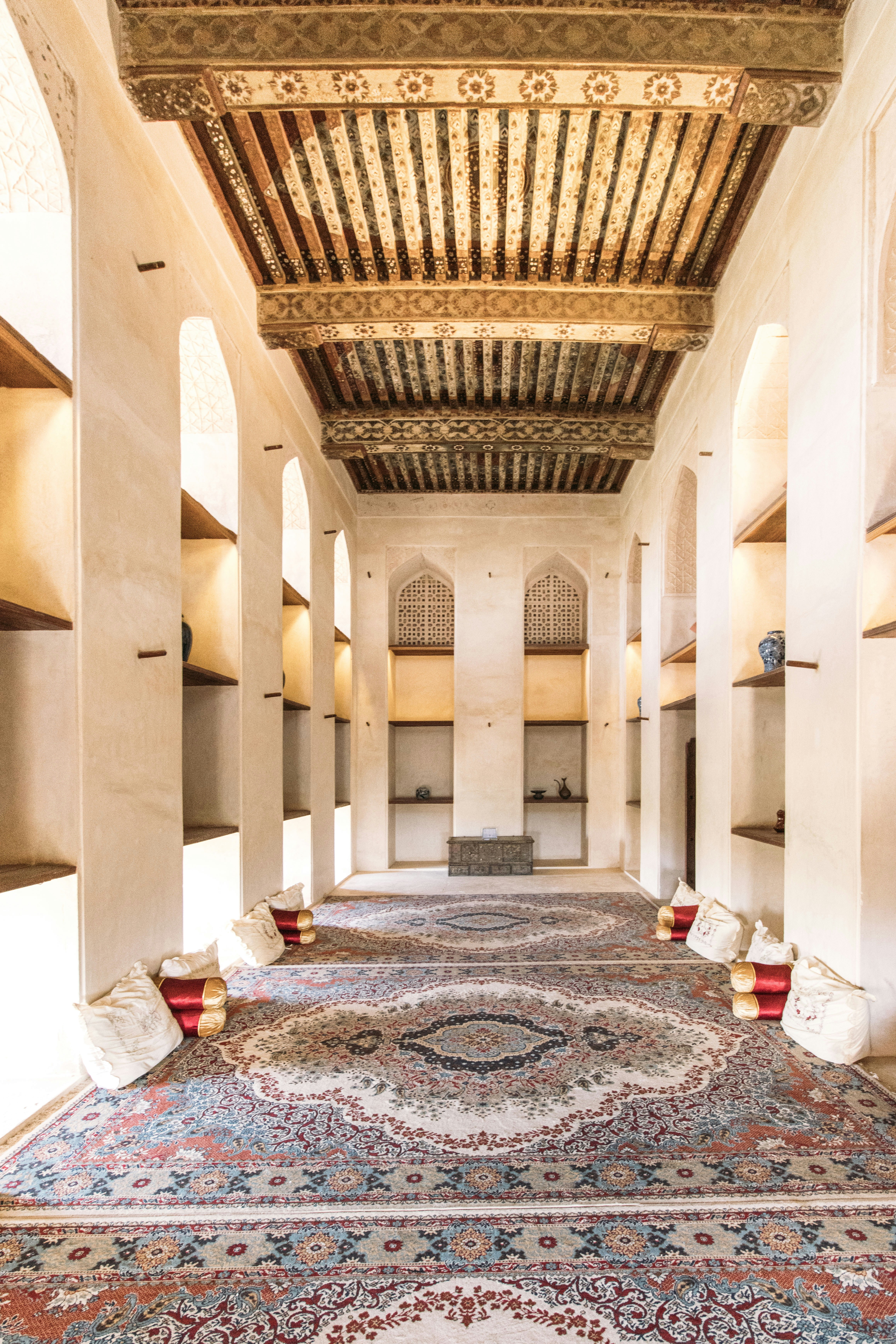 Carved Ceiling and Carpeted Corridor: A Quiet Hall of Arches