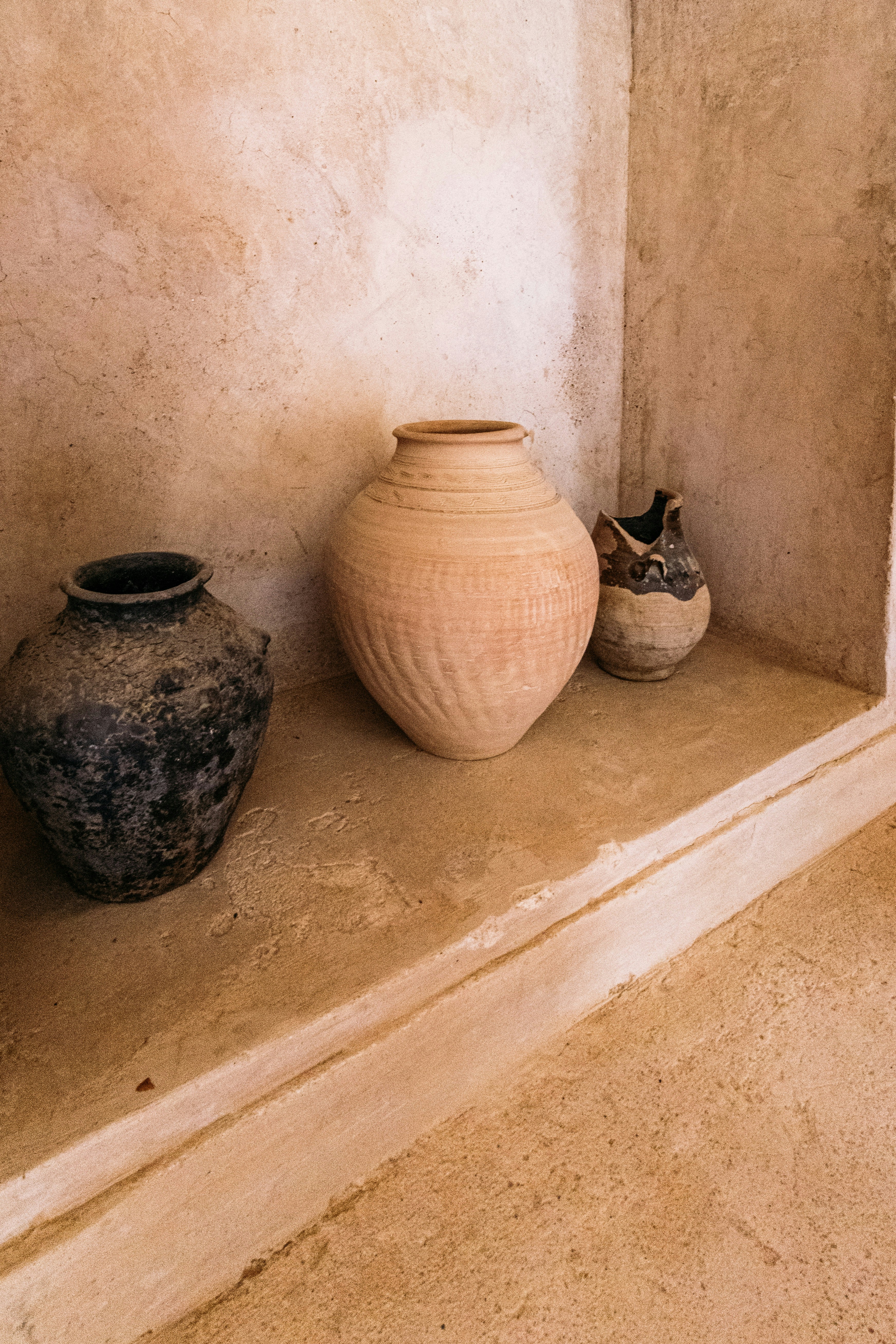 Three Earthen Vessels in a Quiet Alcove