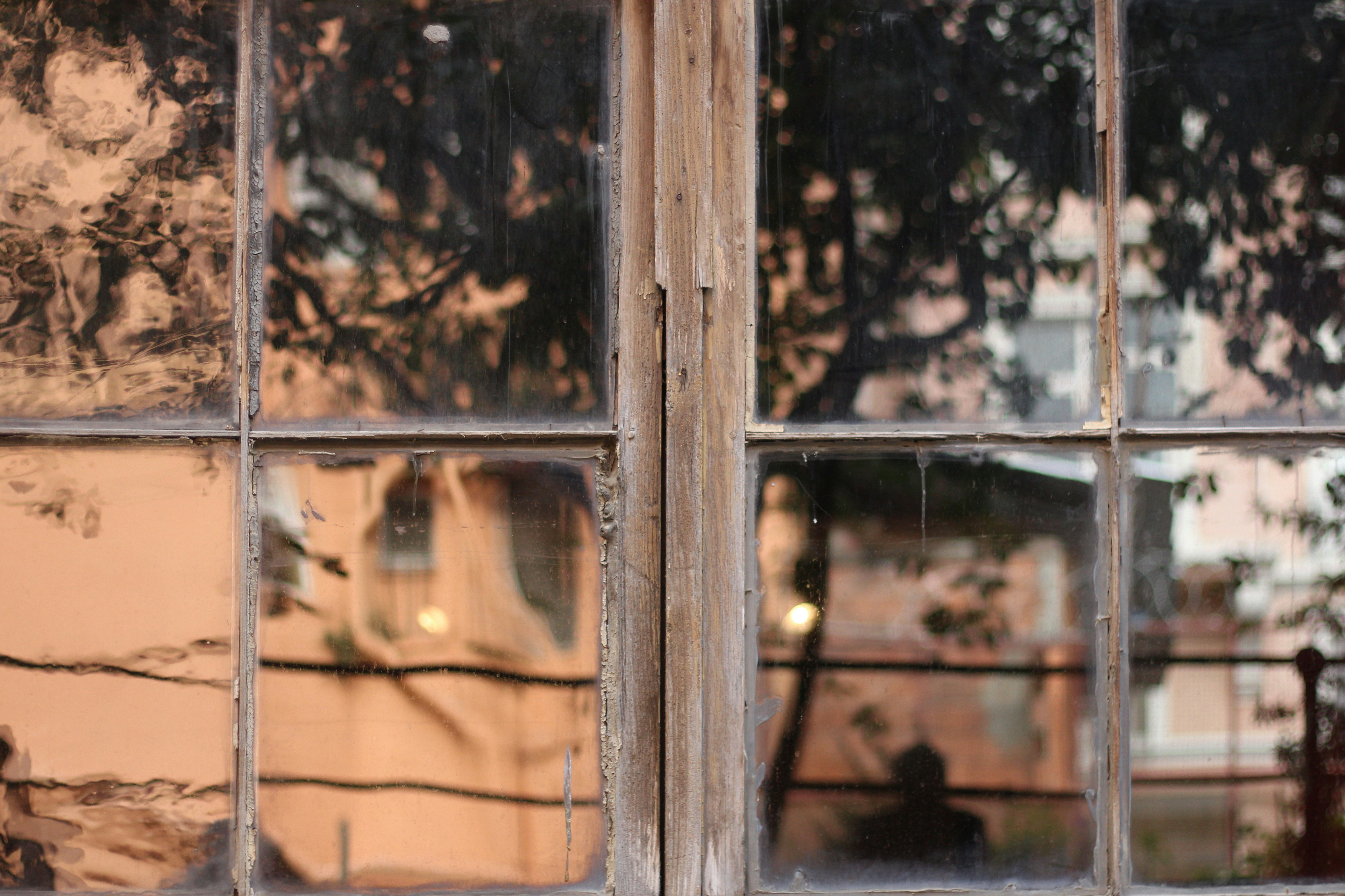 Weathered Windowpanes Reflect a Quiet Street Morning