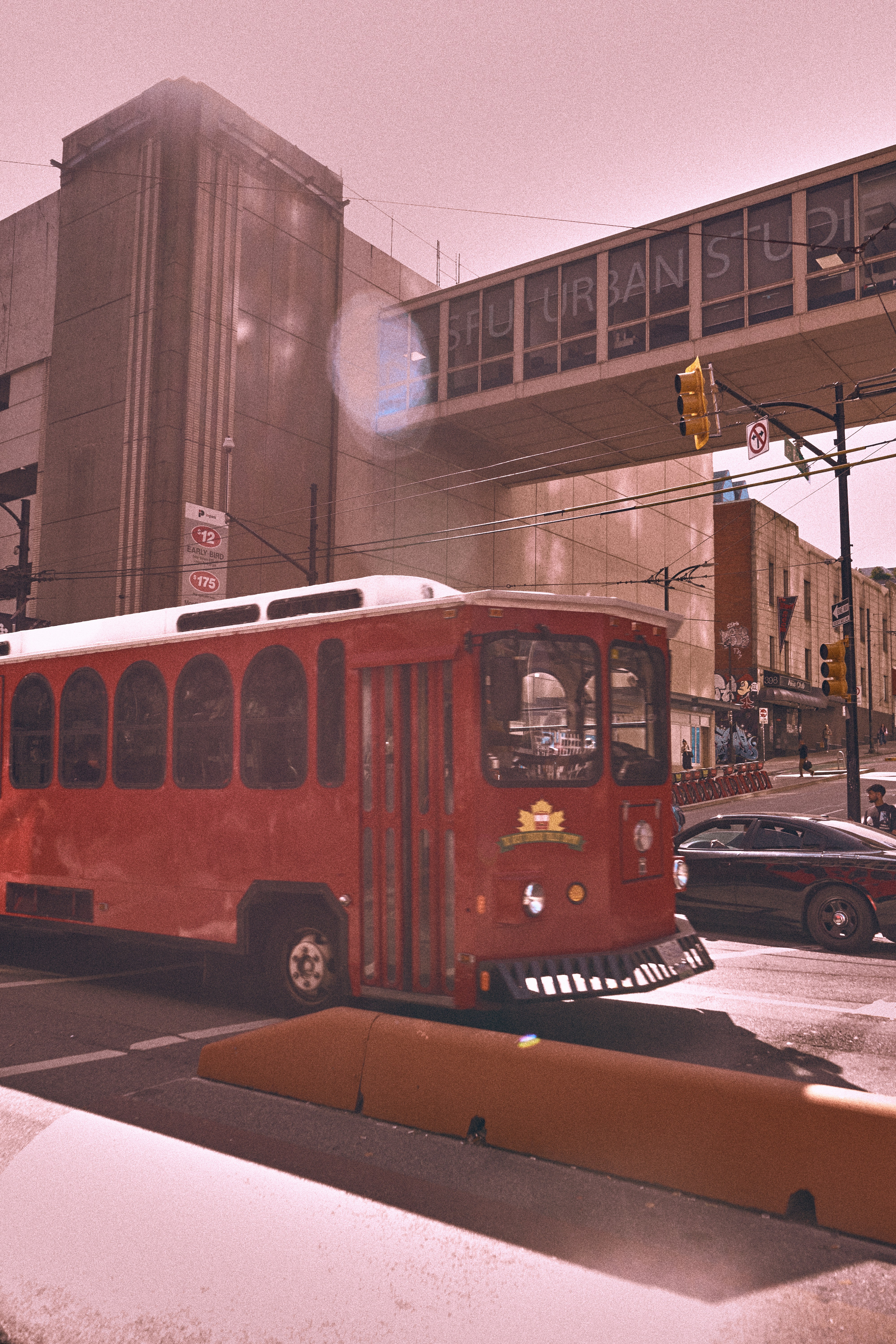 Red Streetcar Crossing Under a City Bridge