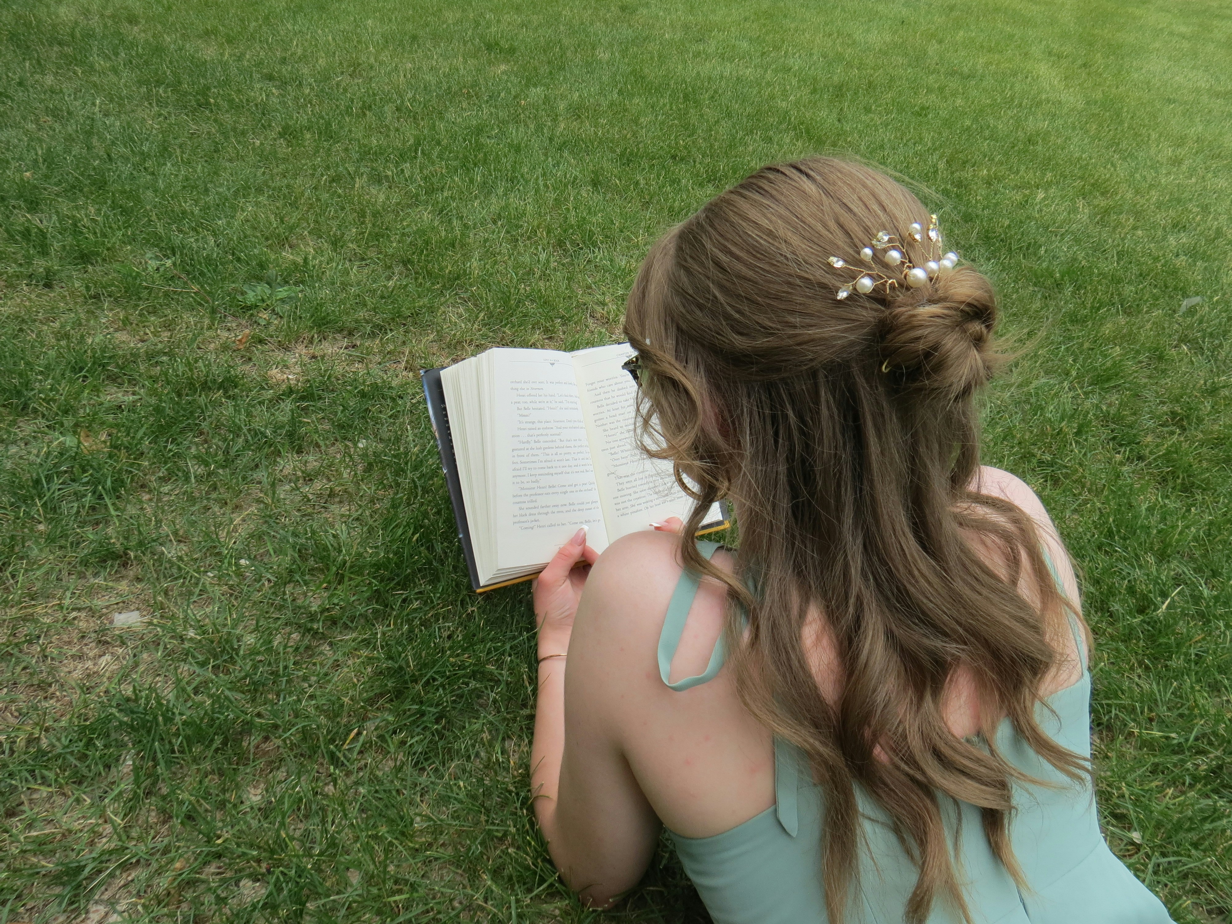 Quiet Focus: A Moment of Reading in the Grass