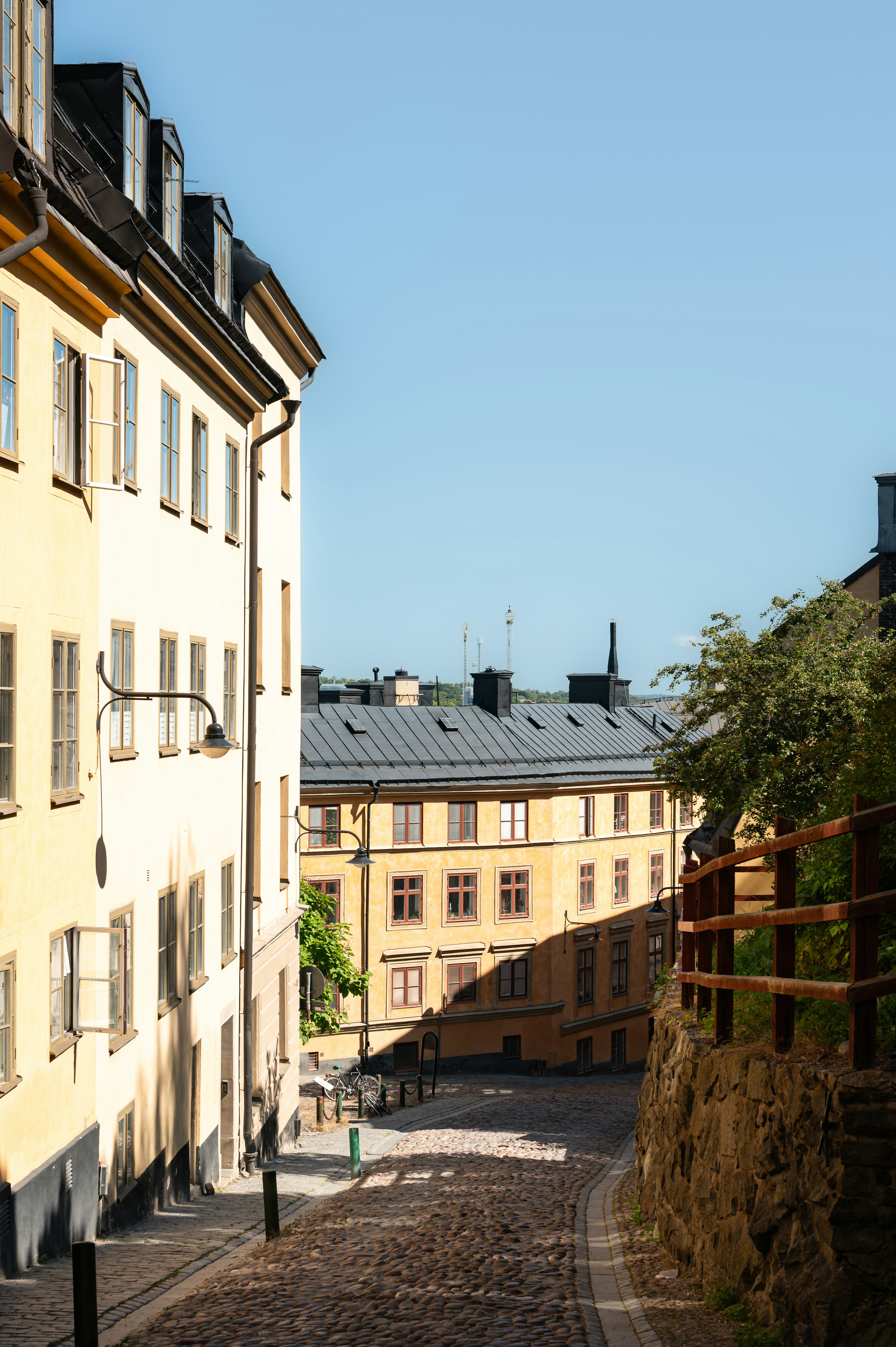 Sunlit Nordic Alley: A Gentle Downhill through Historic Yellow Facades