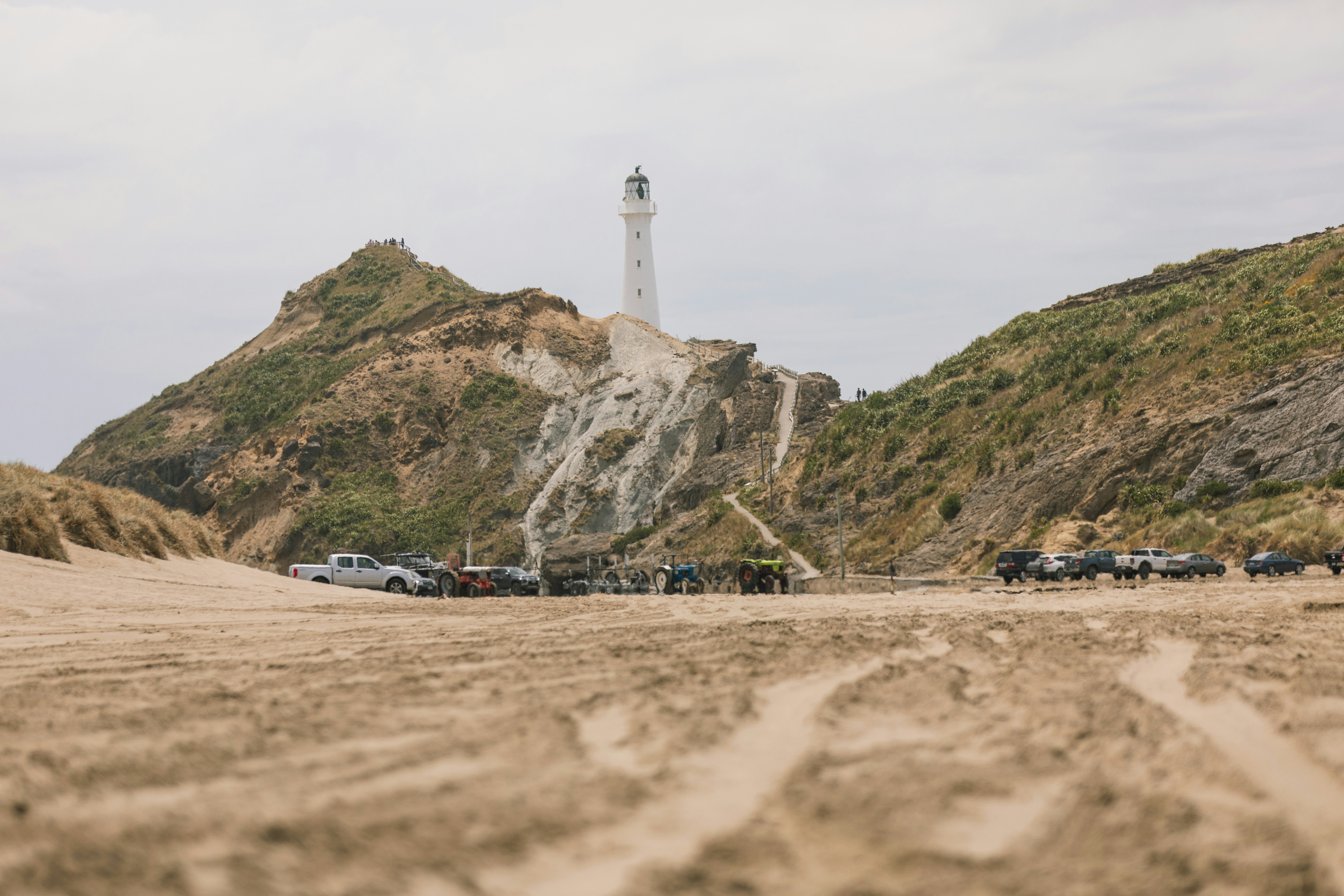 Lighthouse Sentinel Over Dune-Bed Beach