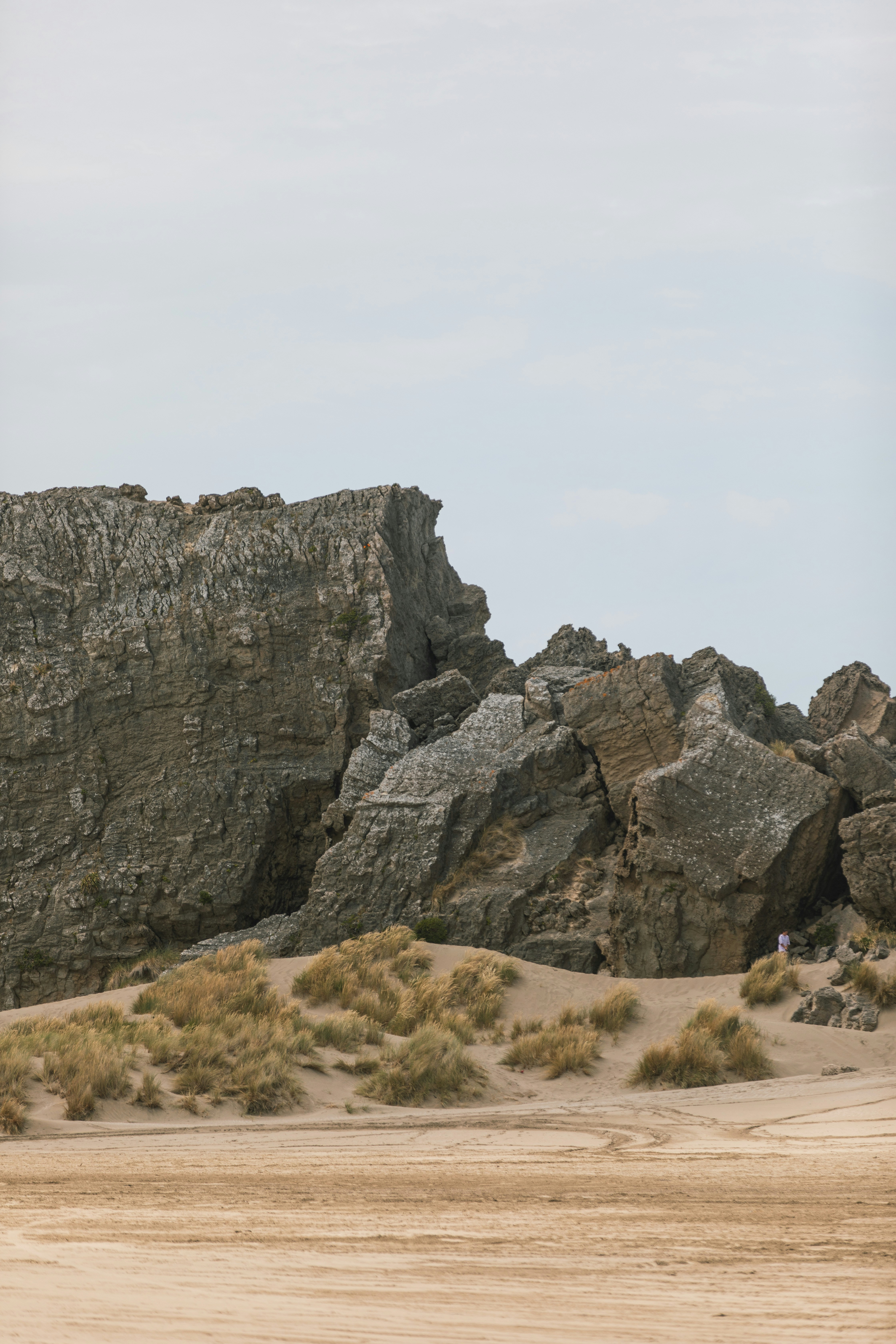 Desert Cliffscape: Quiet Sands Embrace the Rugged Stack