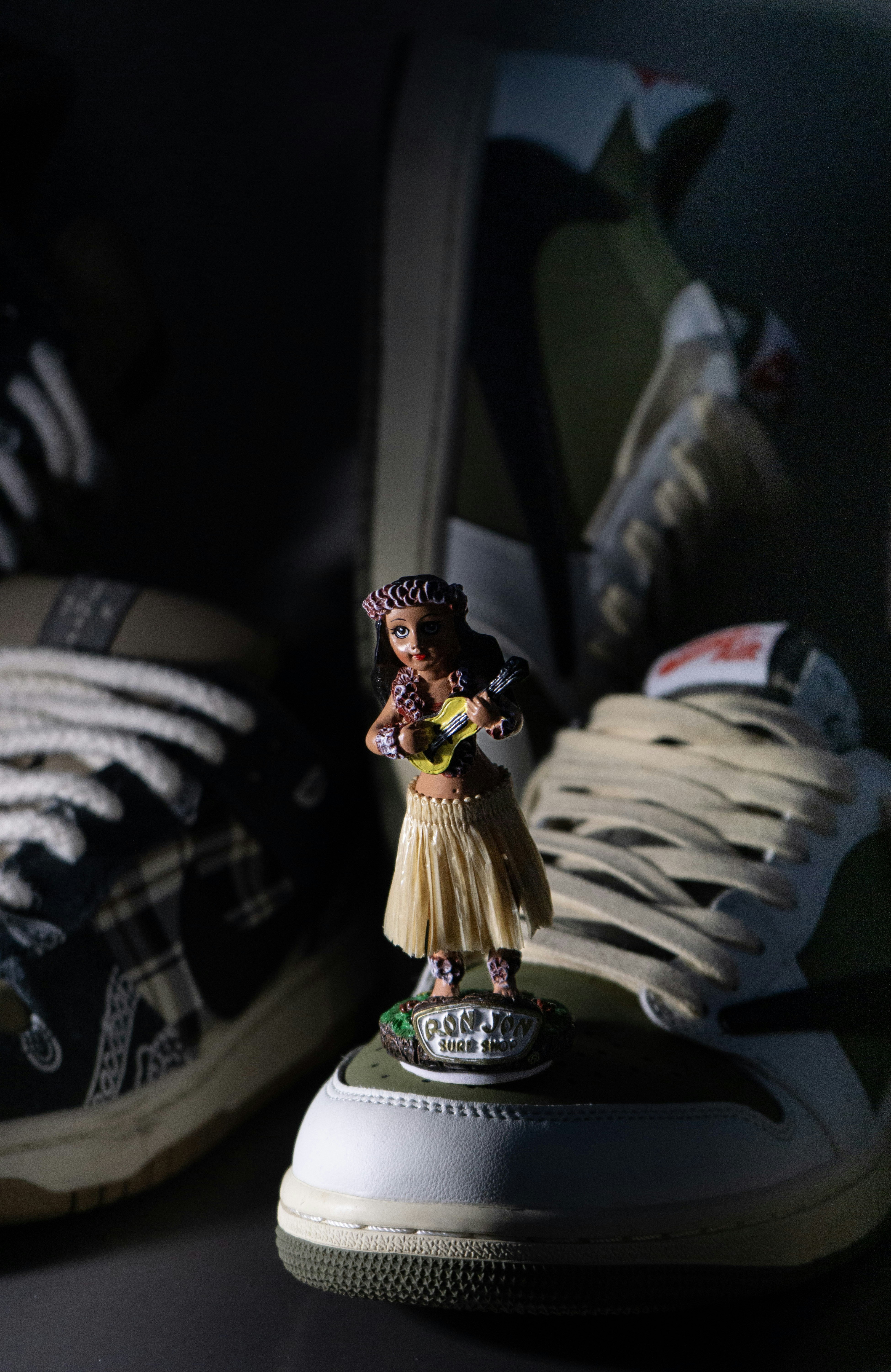 Tiny Hero on a Big Stage: The Figurine Stands Among Sneakers