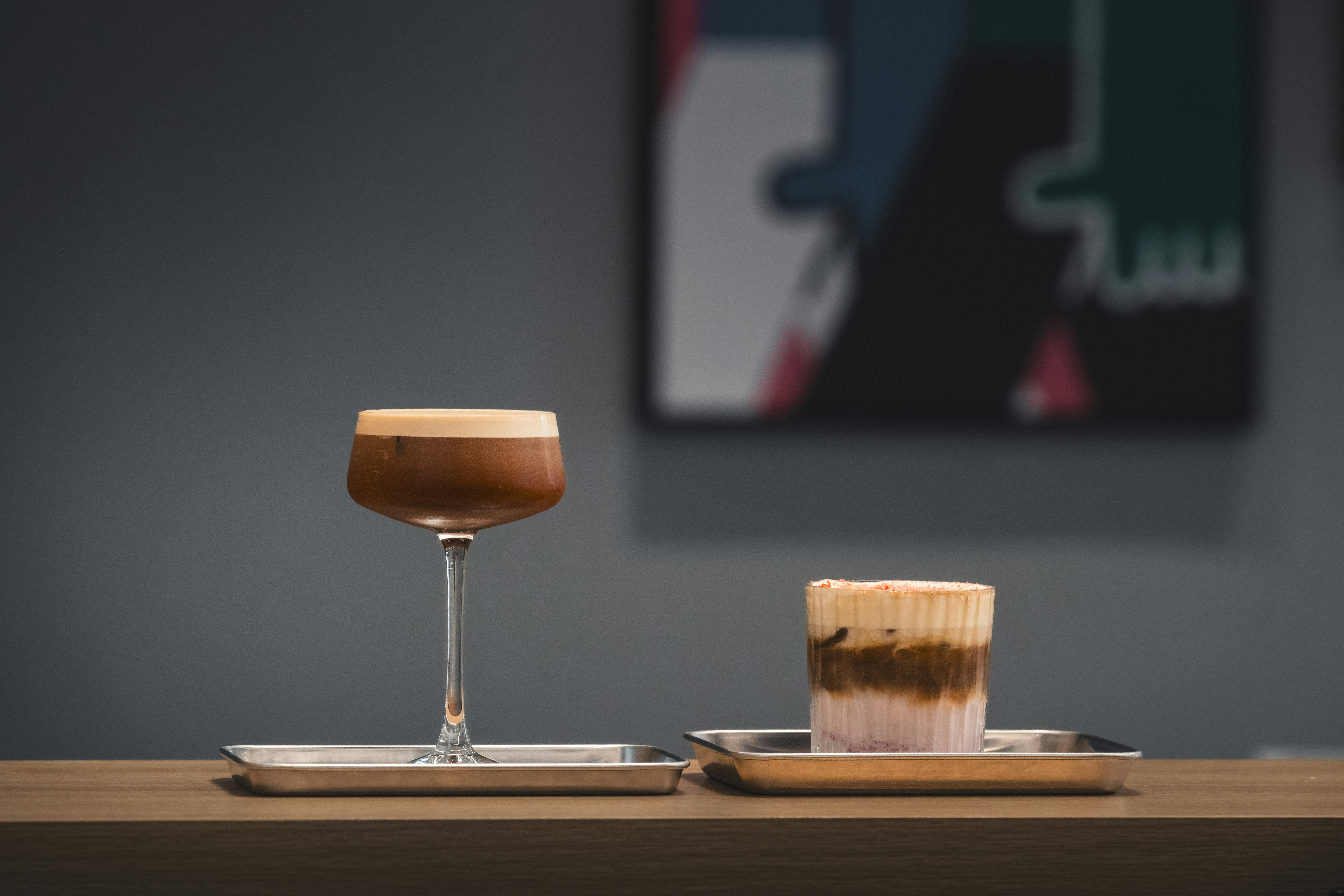 Two Tranquil Sips: A Latte on Steel and a Layered Drip