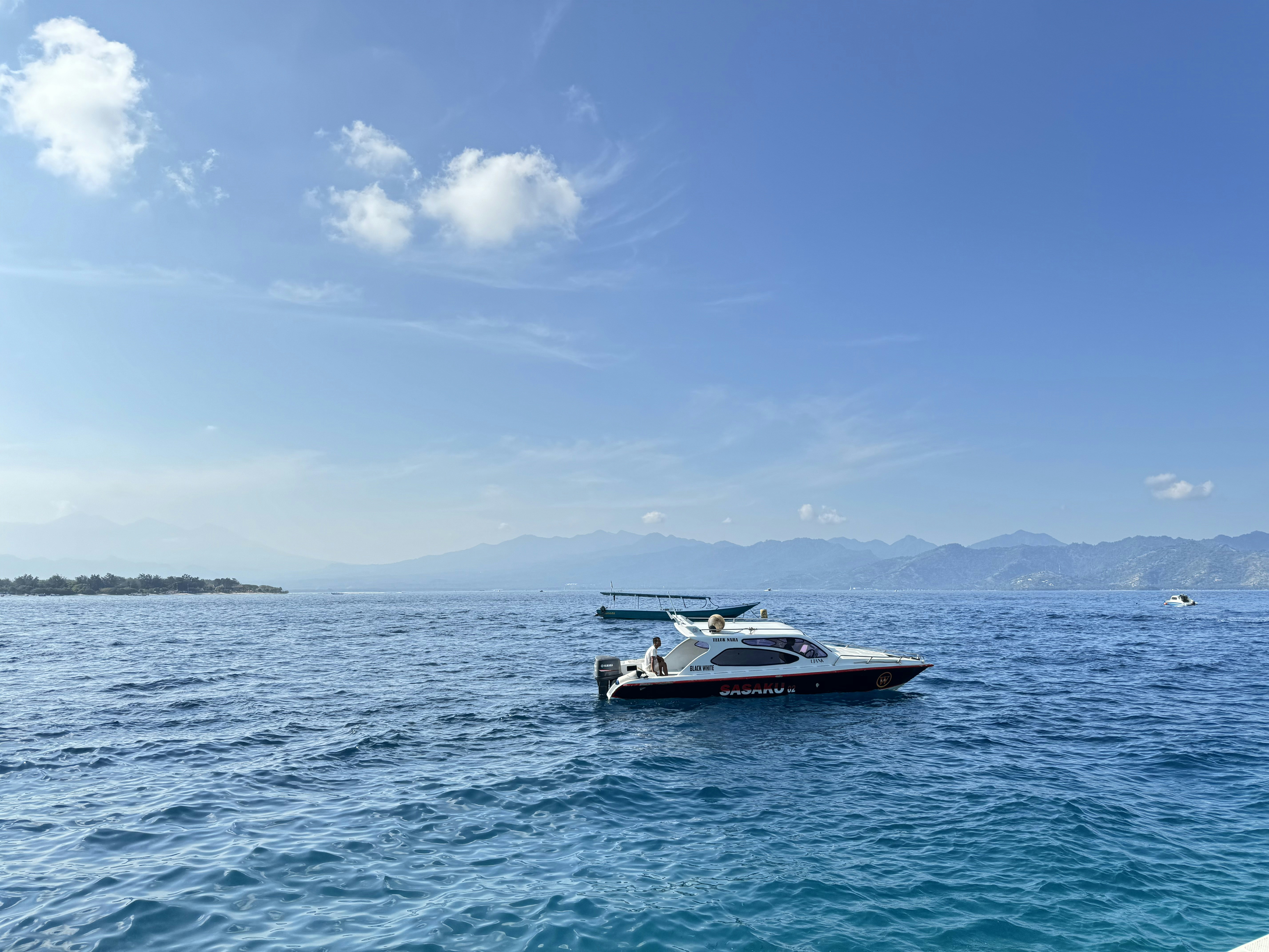 Sea Ghosts: A White Boat Drifts Between Blue Horizons