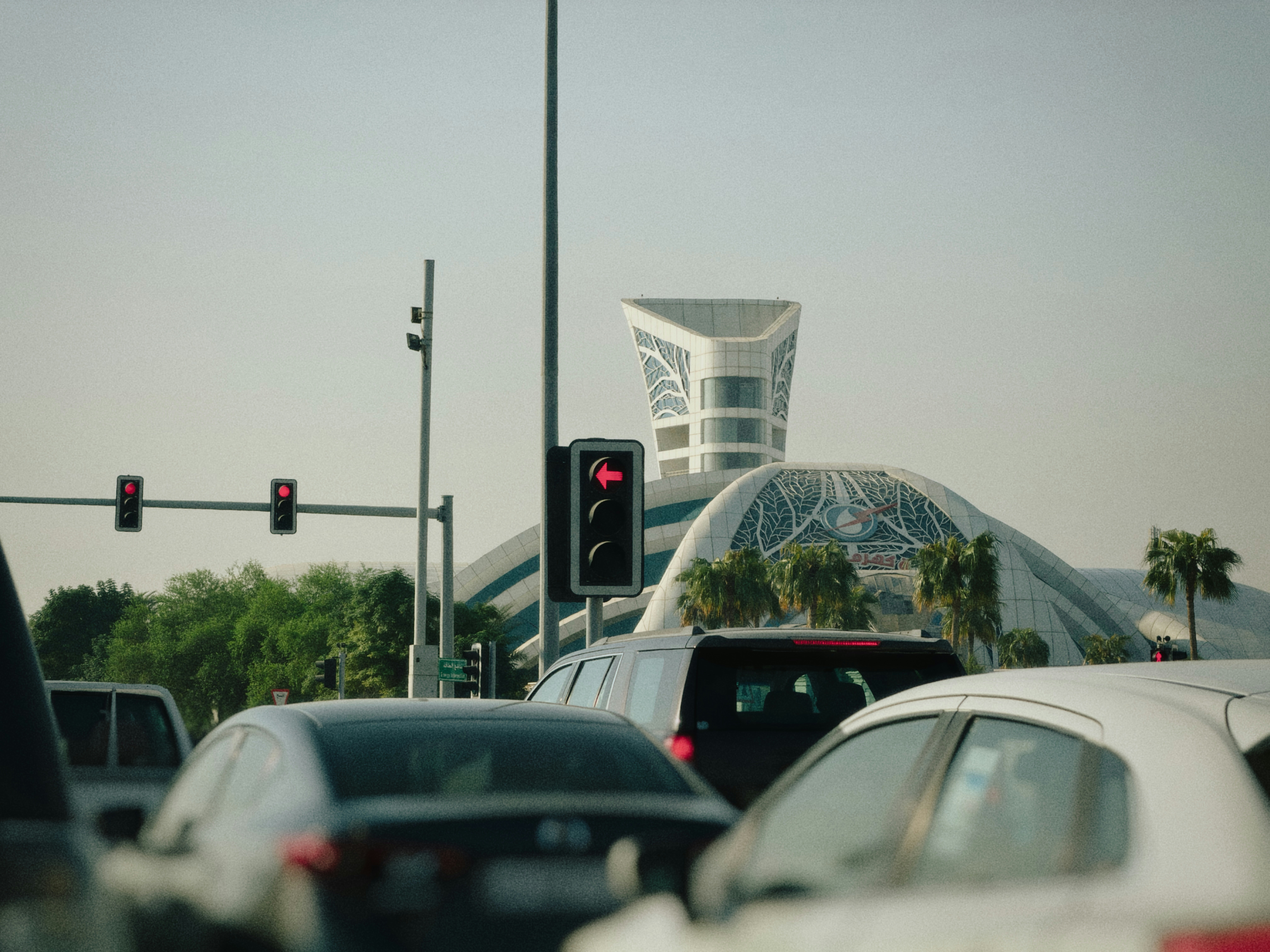Urban Intersection: Traffic Signals and Modern Architecture Framing a Sunset Sky