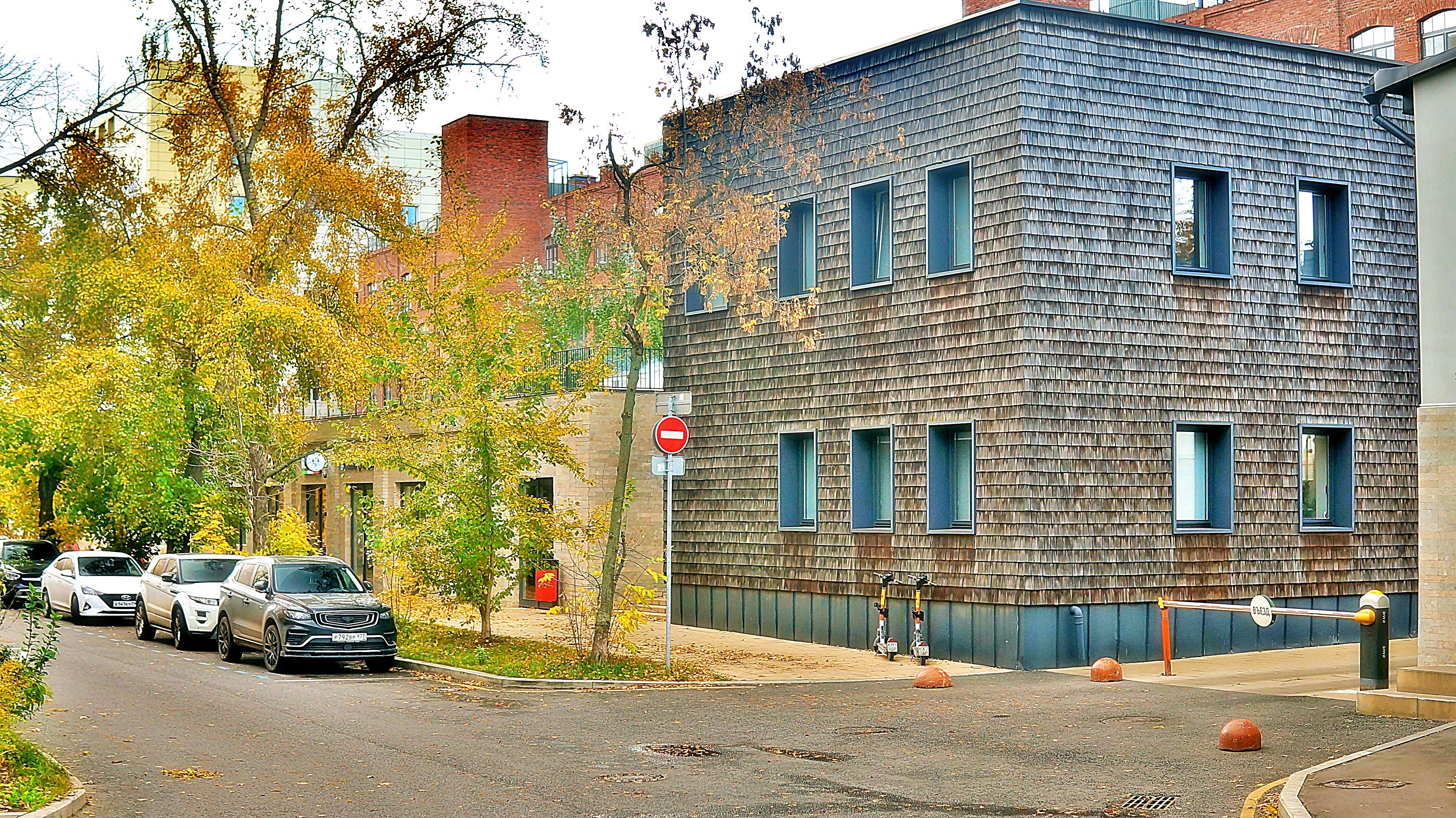Cornered Street: Modern Brick Block Overlooked by Autumn Trees