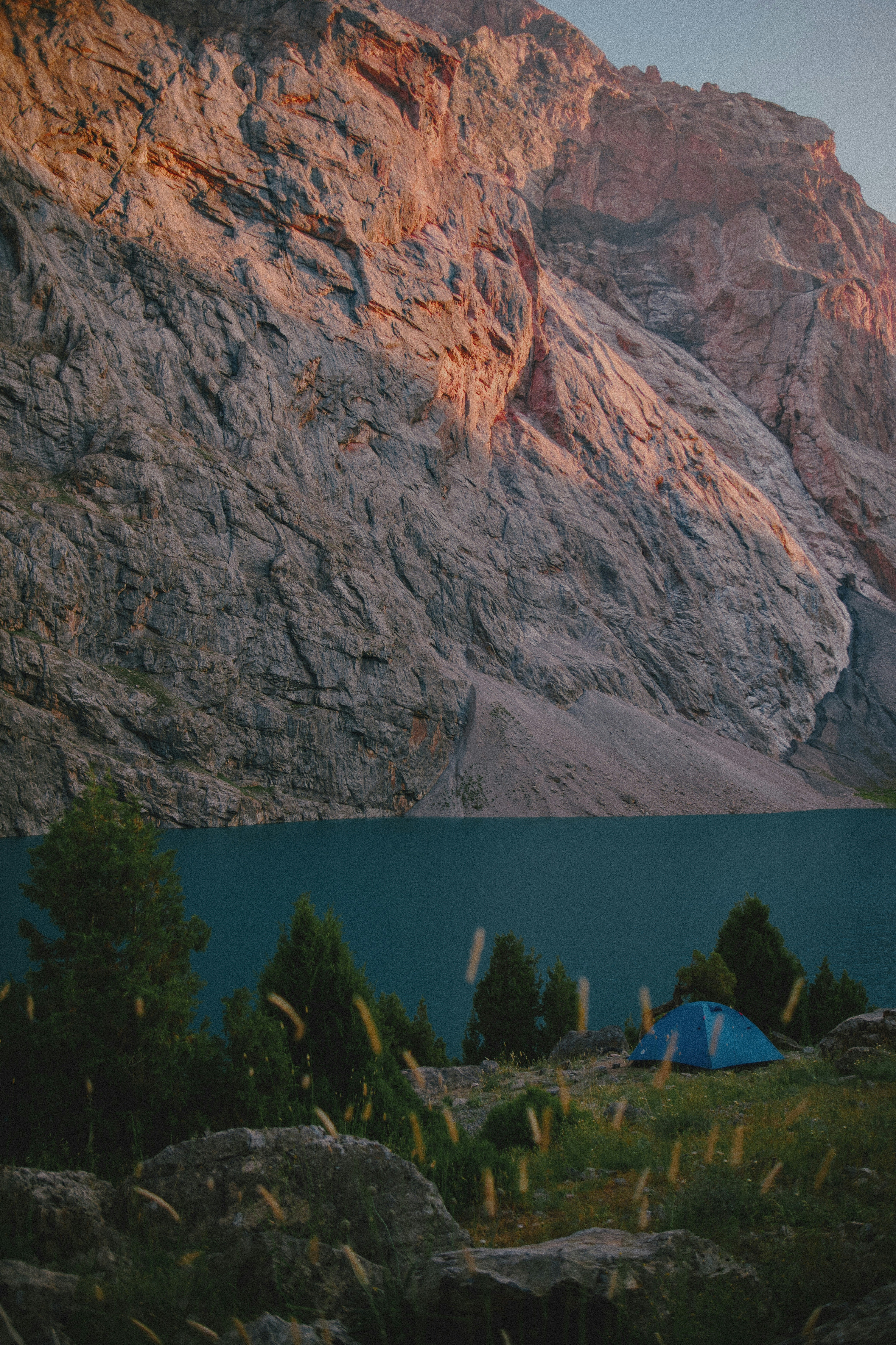 Hidden Camp by a Glacial Lake Beneath Crimson cliffs