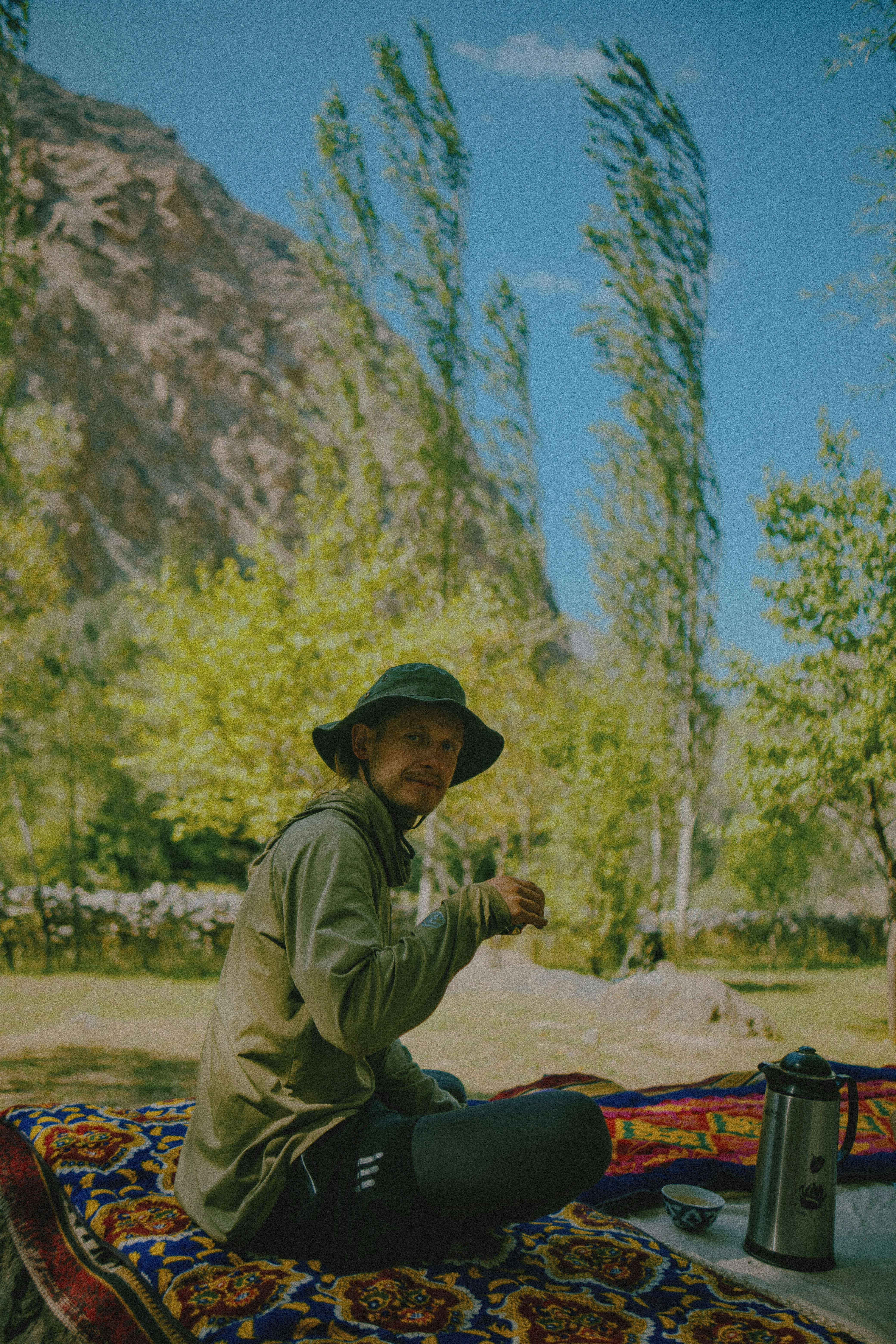 Picnic in the Wind: A Bearded Hiker under Tall Trees
